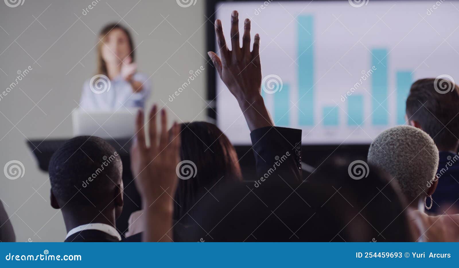 Audience of Business People Asking the Speaker a Question while Lifting ...