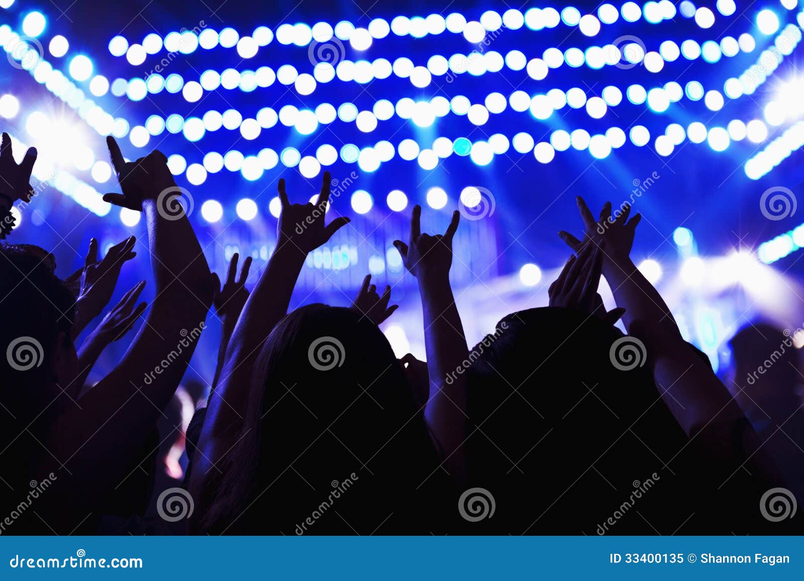Audience Watching a Rock Show, Hands in the Air, Rear View, Stage ...