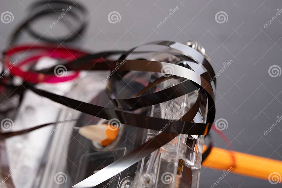 Audio Cassette And Pencil On A Black Table Old Magnetic Data Carrier