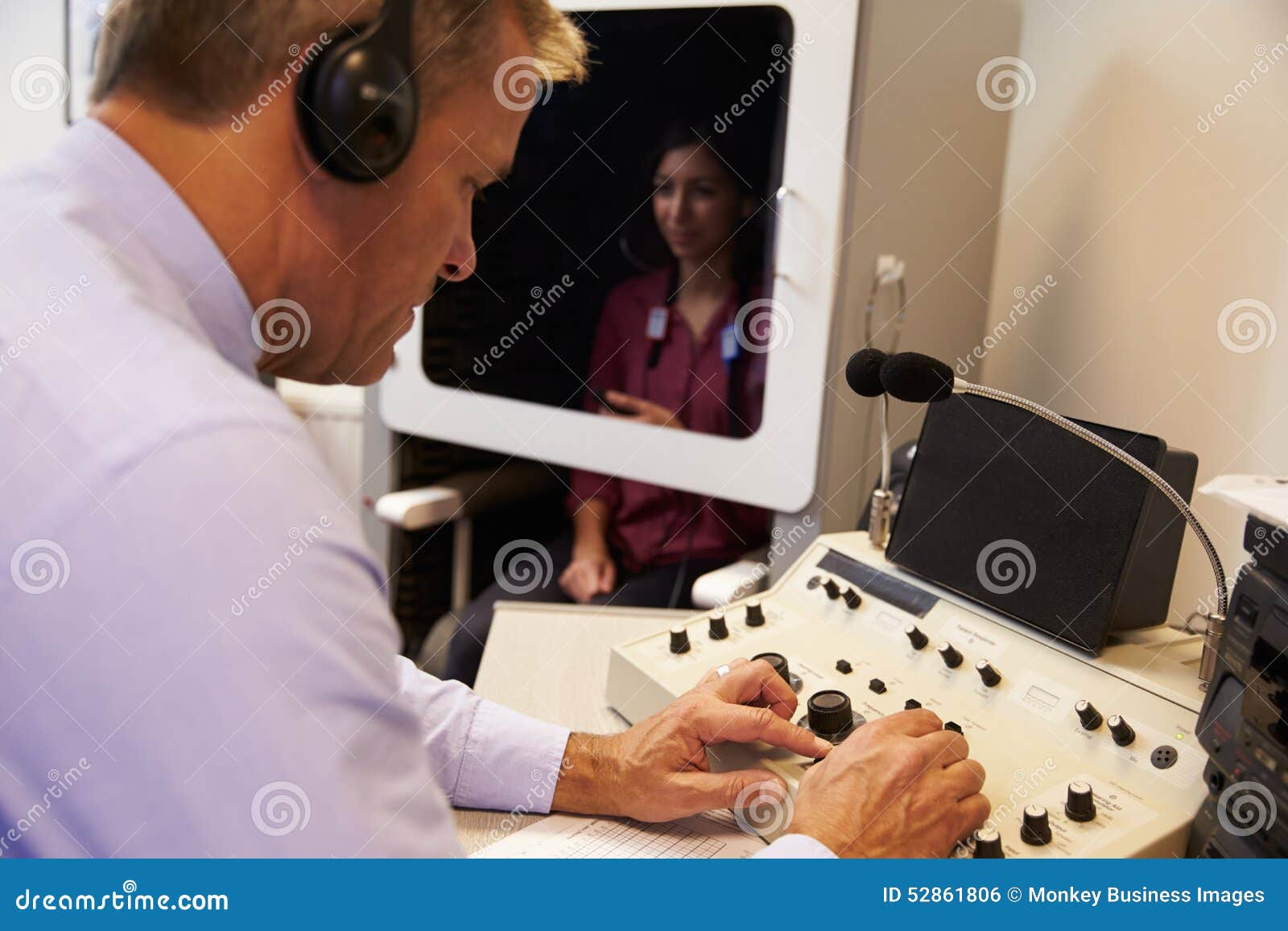 Audiologist Carrying Out Hearing Test on Female Patient Stock Photo ...