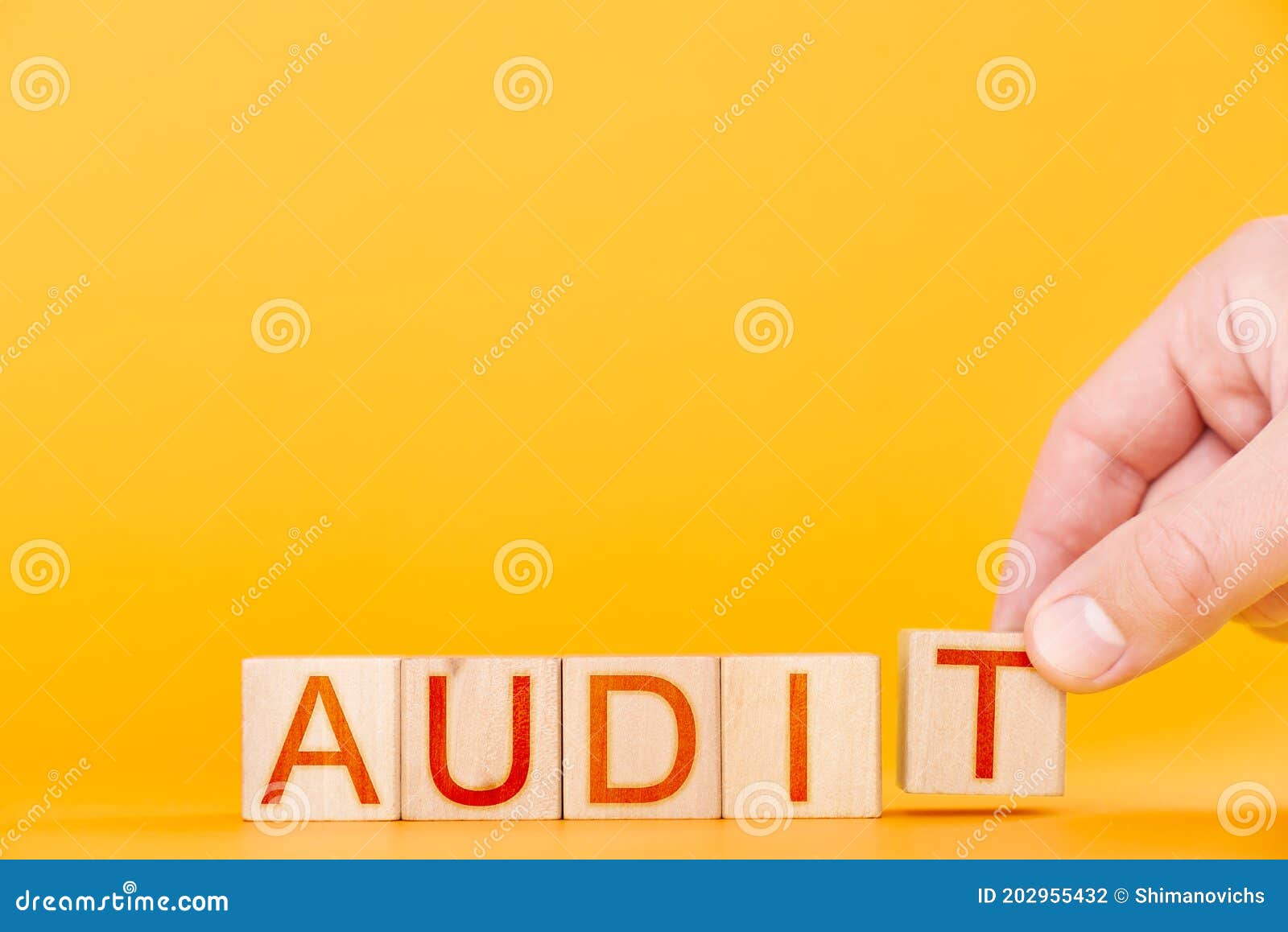 Audit. Man Puts Wooden Cubes into the Word Audit on Orange Background ...