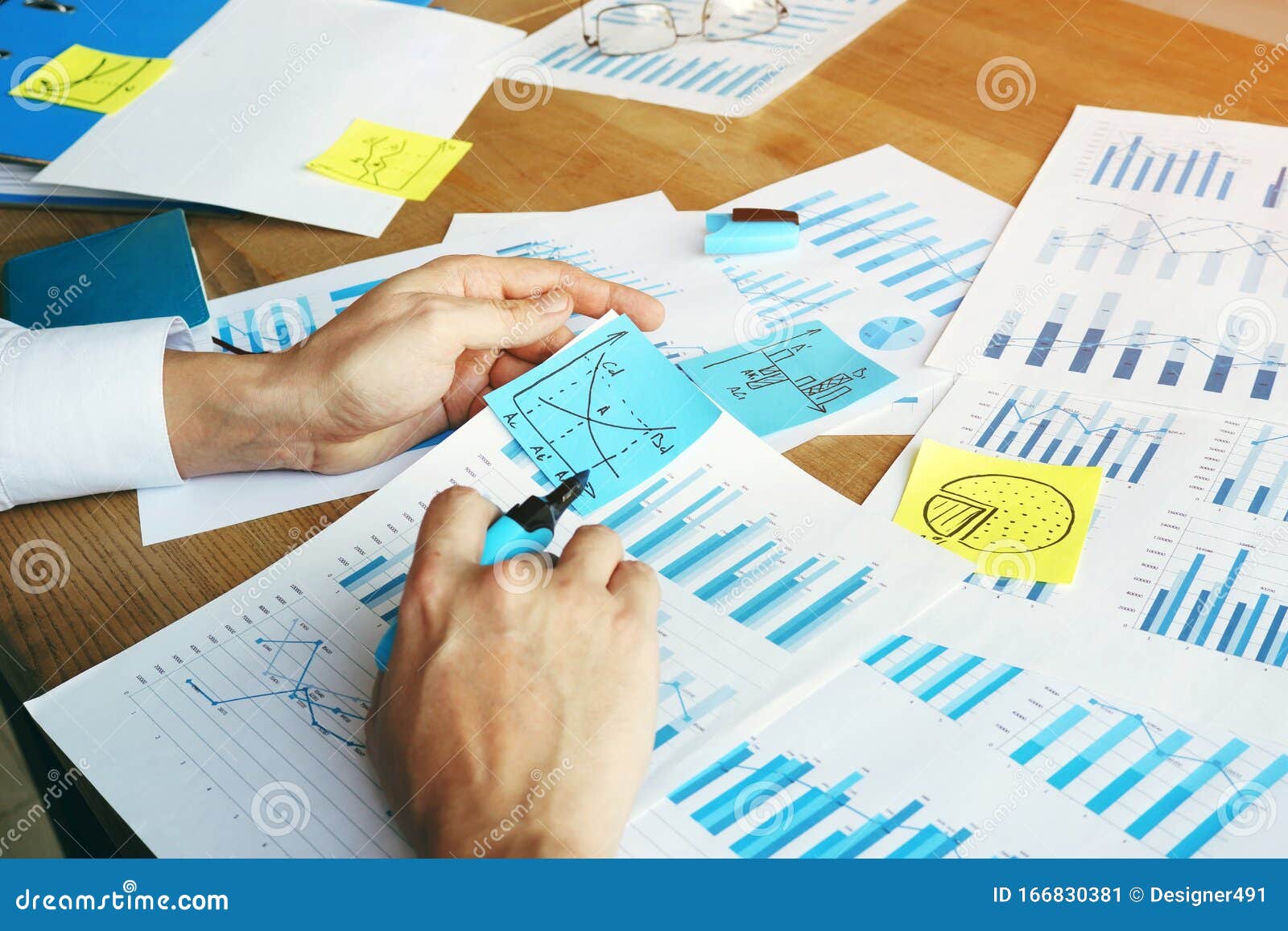 Auditor is Checking Financial Report with Charts and Business Graphs ...