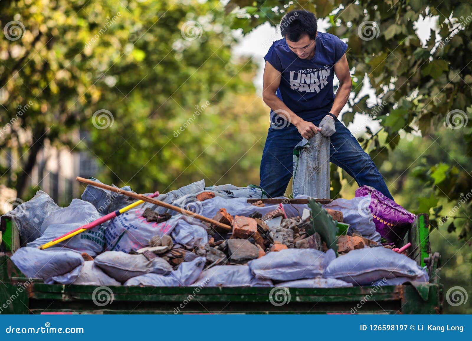 Worker Loading and Unloading Construction Waste on a Car Editorial ...