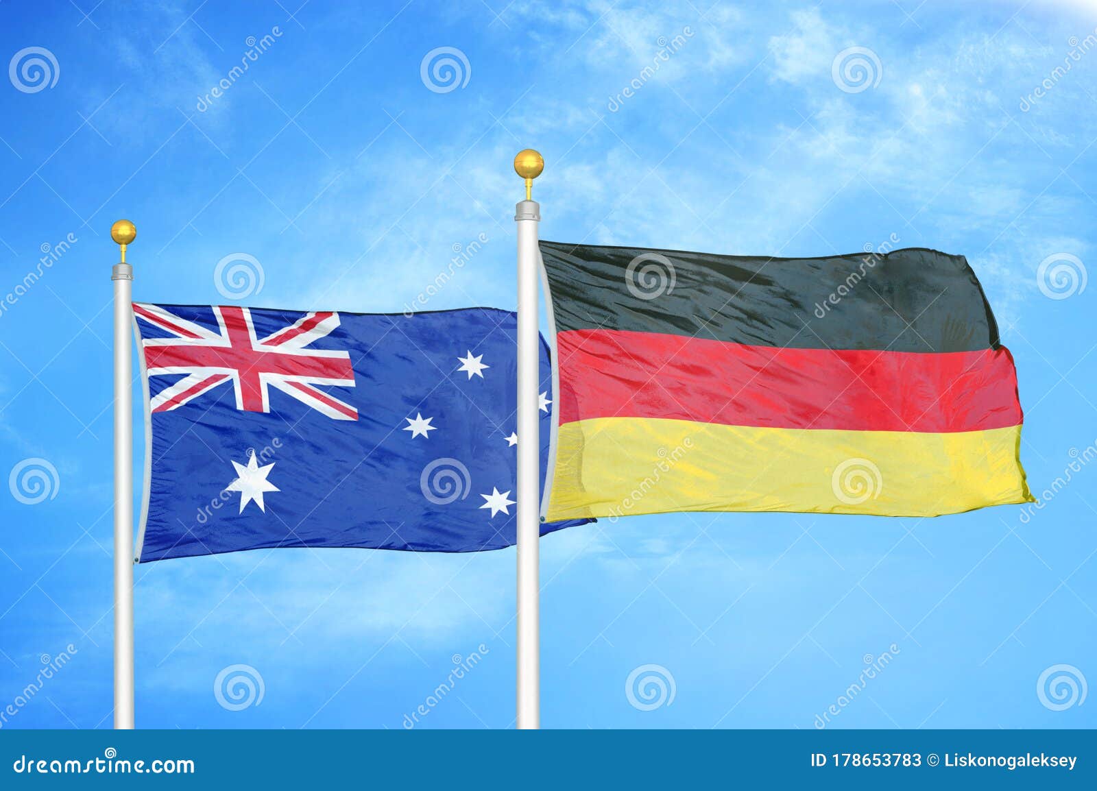 Australia and Germany Two Flags on Flagpoles and Blue Cloudy Sky Stock ...