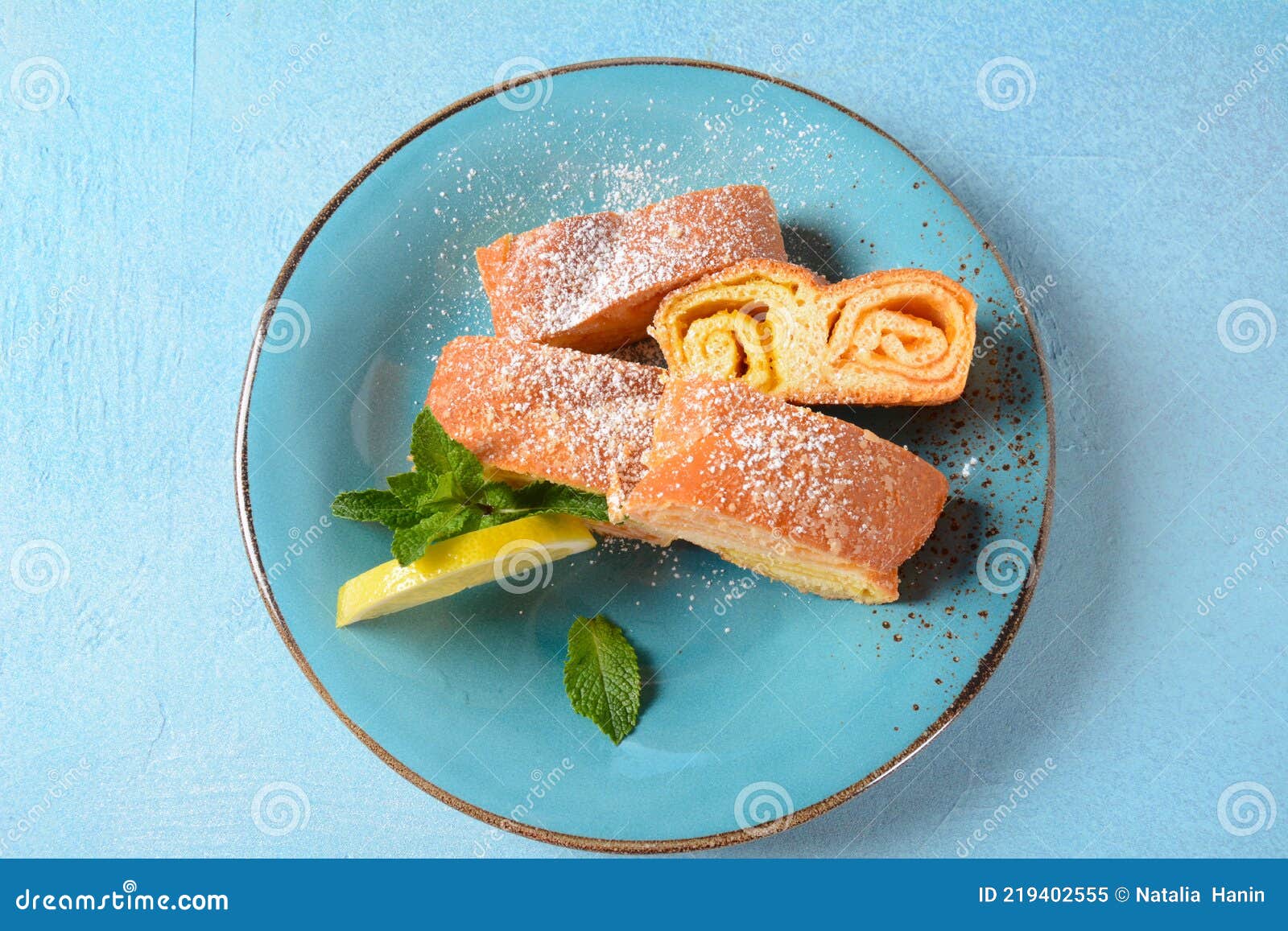 Austrian Strudel with Lemon and Mint and with Powdered Sugar on a Plate ...