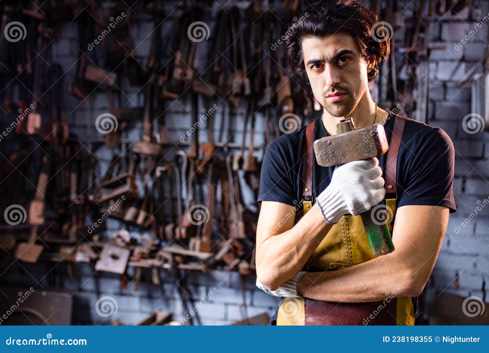 Authentic Blacksmith Man Forges a Metal Product in Dark Indoors Studio ...