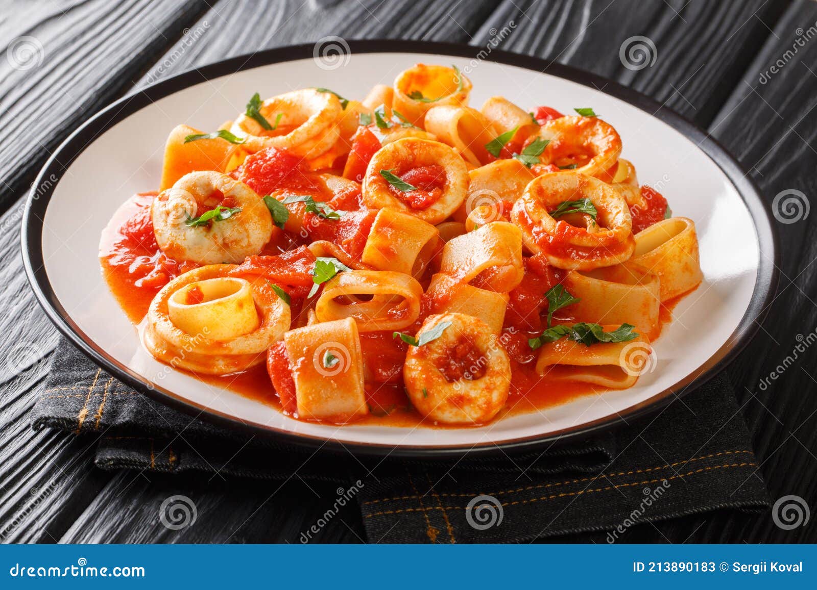Authentic Italian Calamarata Pasta with Squid and Tomato Close-up in a ...