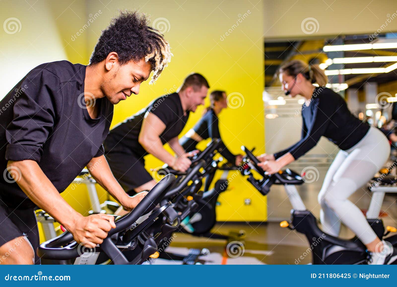 Authentic Mixed Race Group Training on Exercise Bikes Teamwork Stock ...