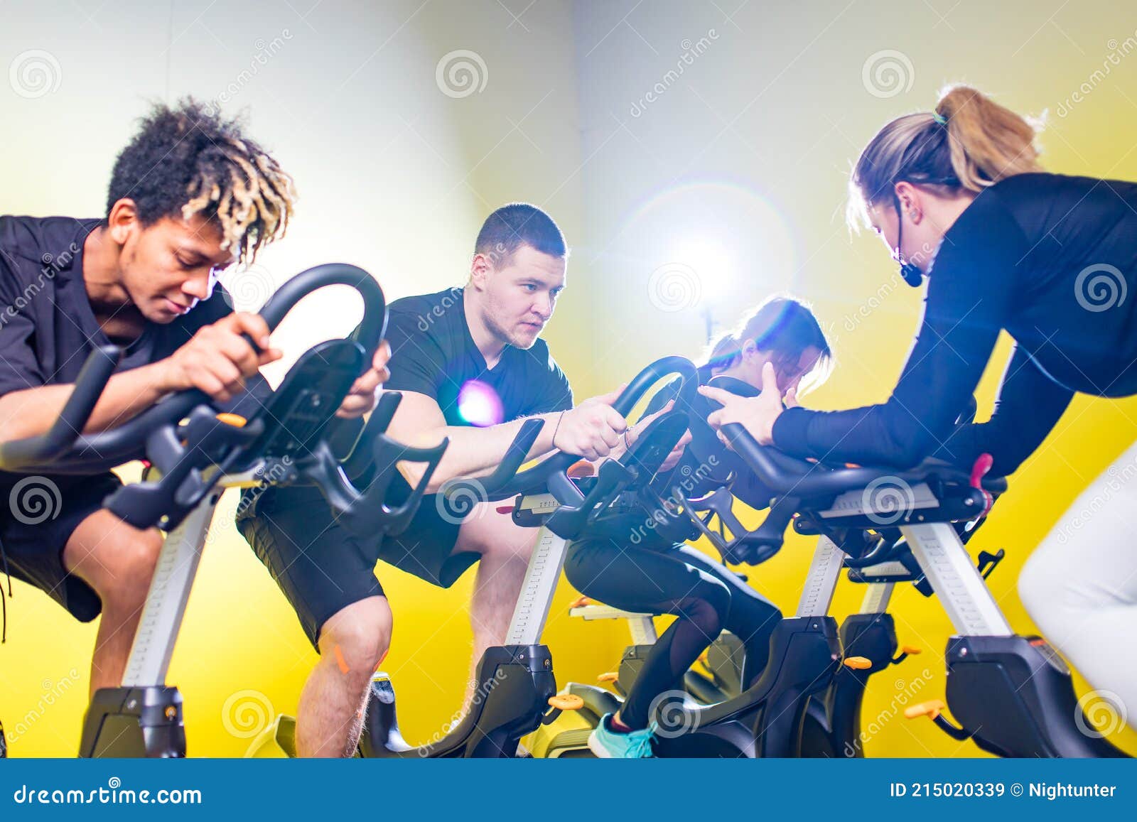 Authentic Mixed Race Group Training on Exercise Bikes Teamwork Stock ...
