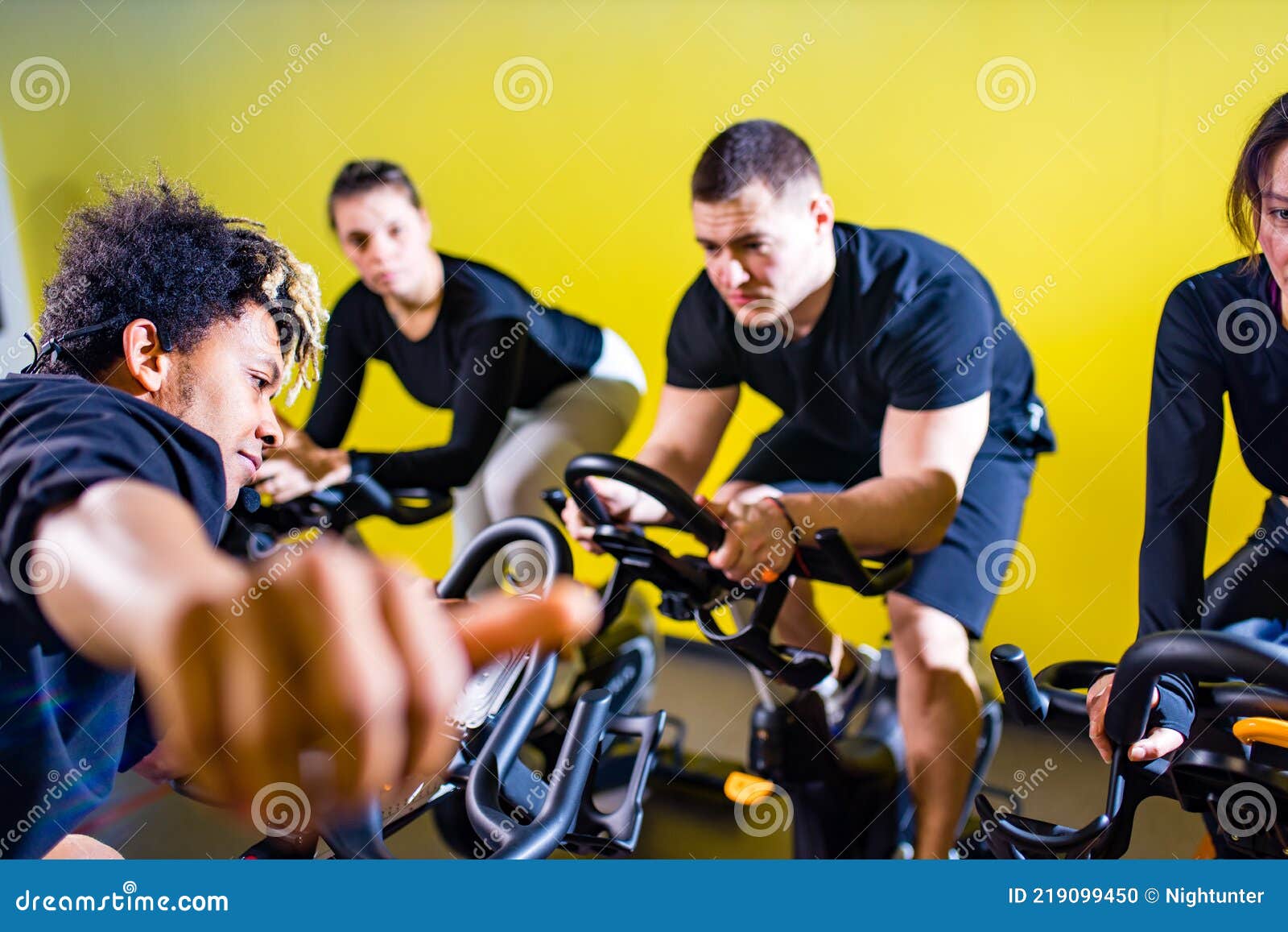 Authentic Mixed Race Group Training on Exercise Bikes Teamwork Stock ...