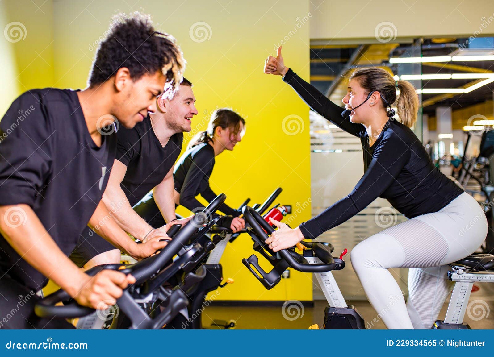Authentic Mixed Race Group Training on Exercise Bikes Teamwork Stock ...
