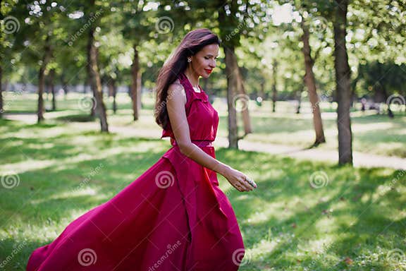 Authentic Portrait Of Beautiful Woman With Long Dark Hair Wearing Red