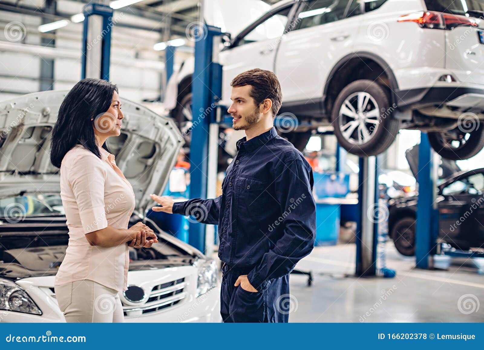 Auto Car Repair Service Center. the Mechanic Communicates with the ...