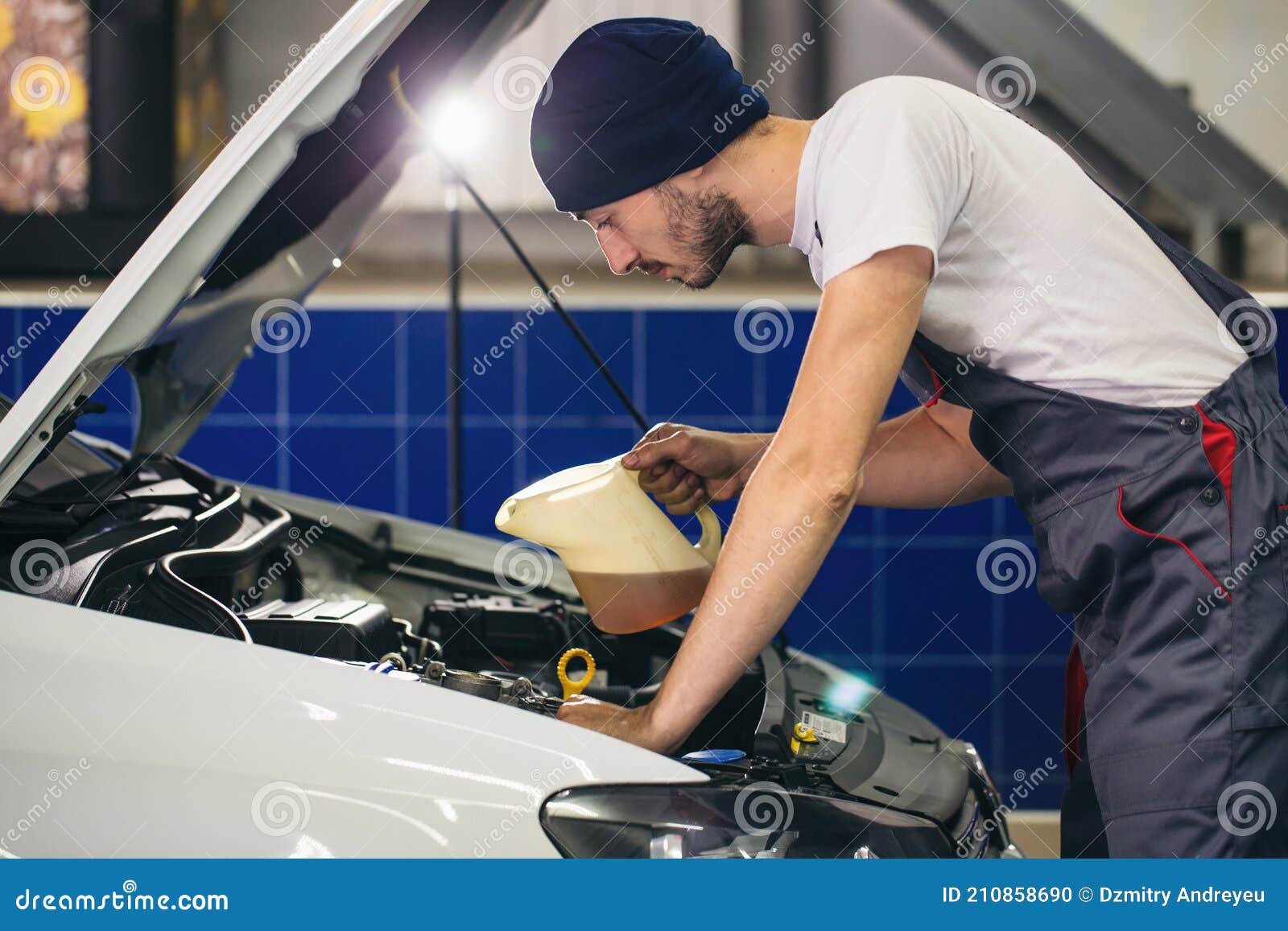 Auto Mechanic is Changing Motor Oil into a Engine Stock Photo - Image ...