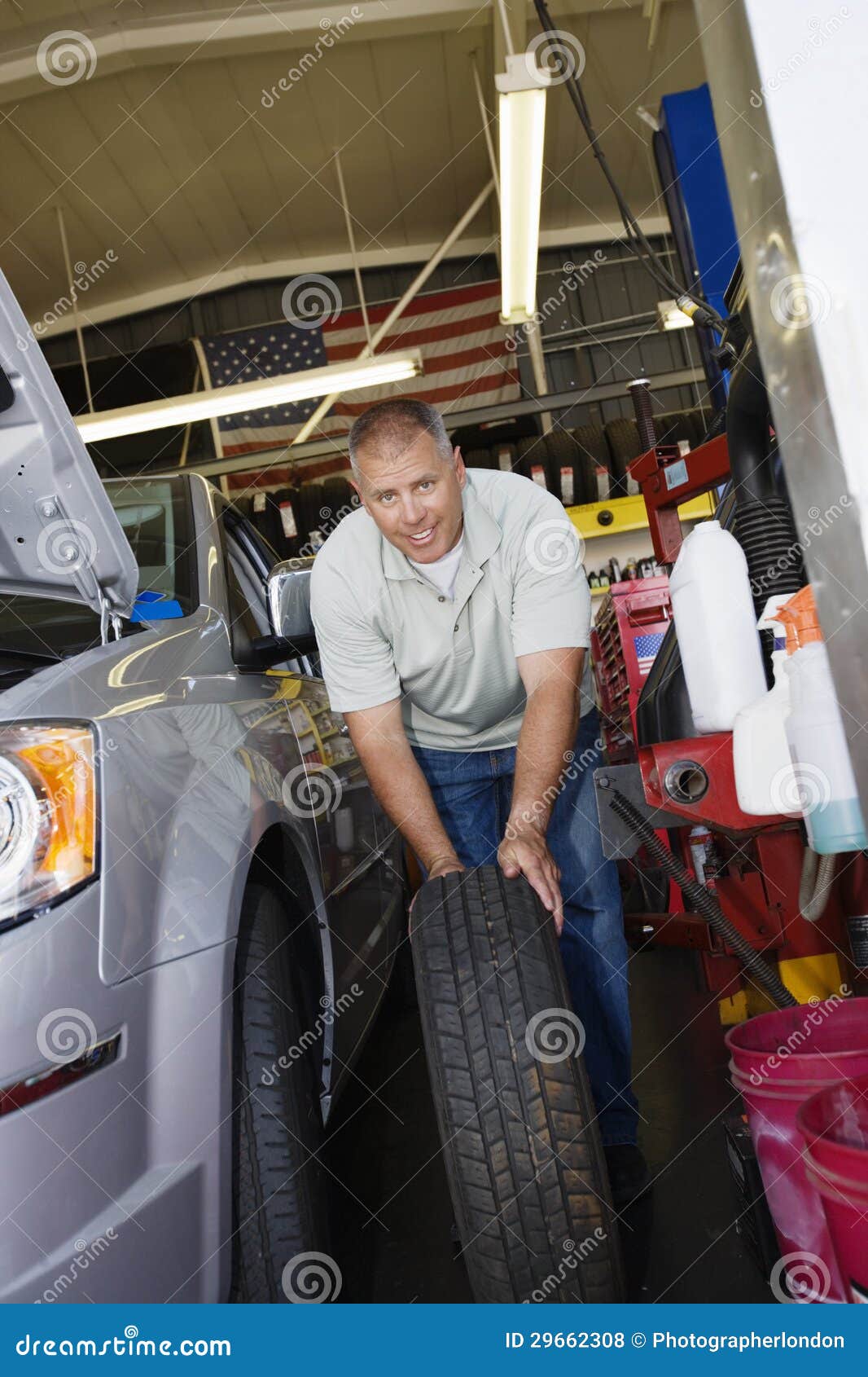 Auto Mechanic Changing a Tire Stock Photo - Image of looking, manual ...