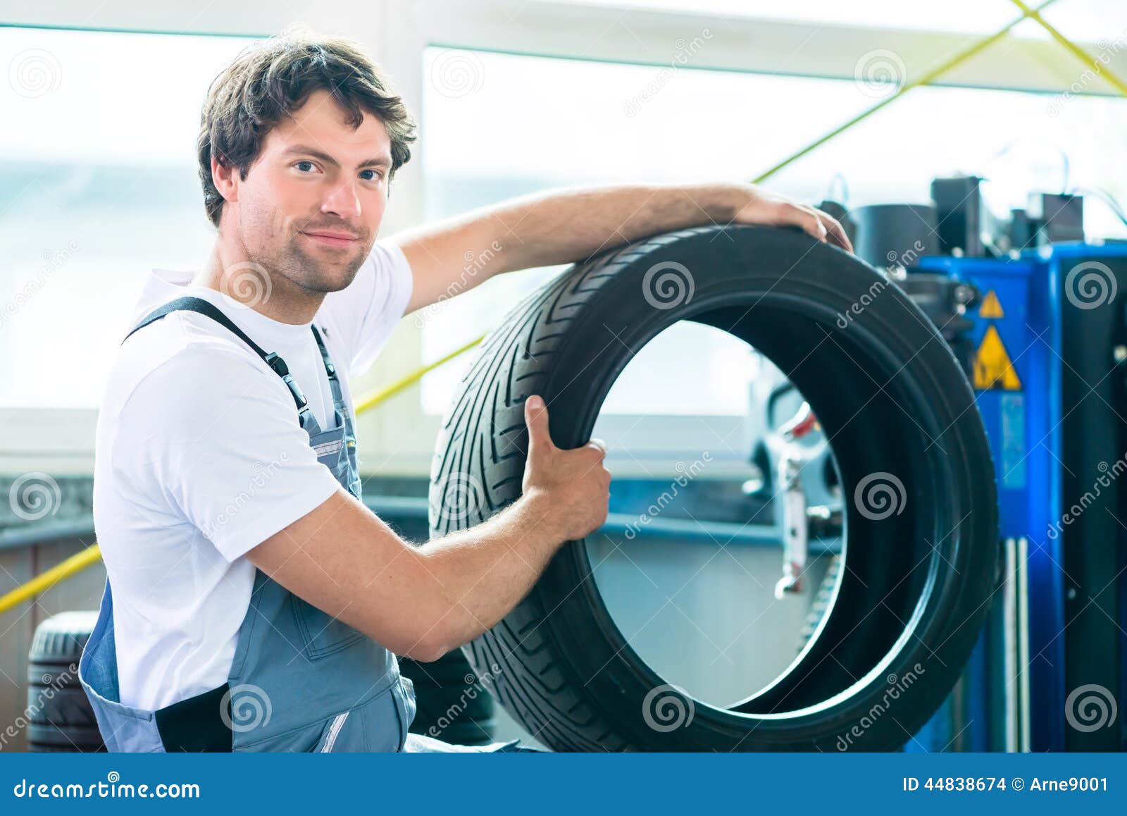 Auto Mechanic Changing Tire in Workshop Stock Photo - Image of ...