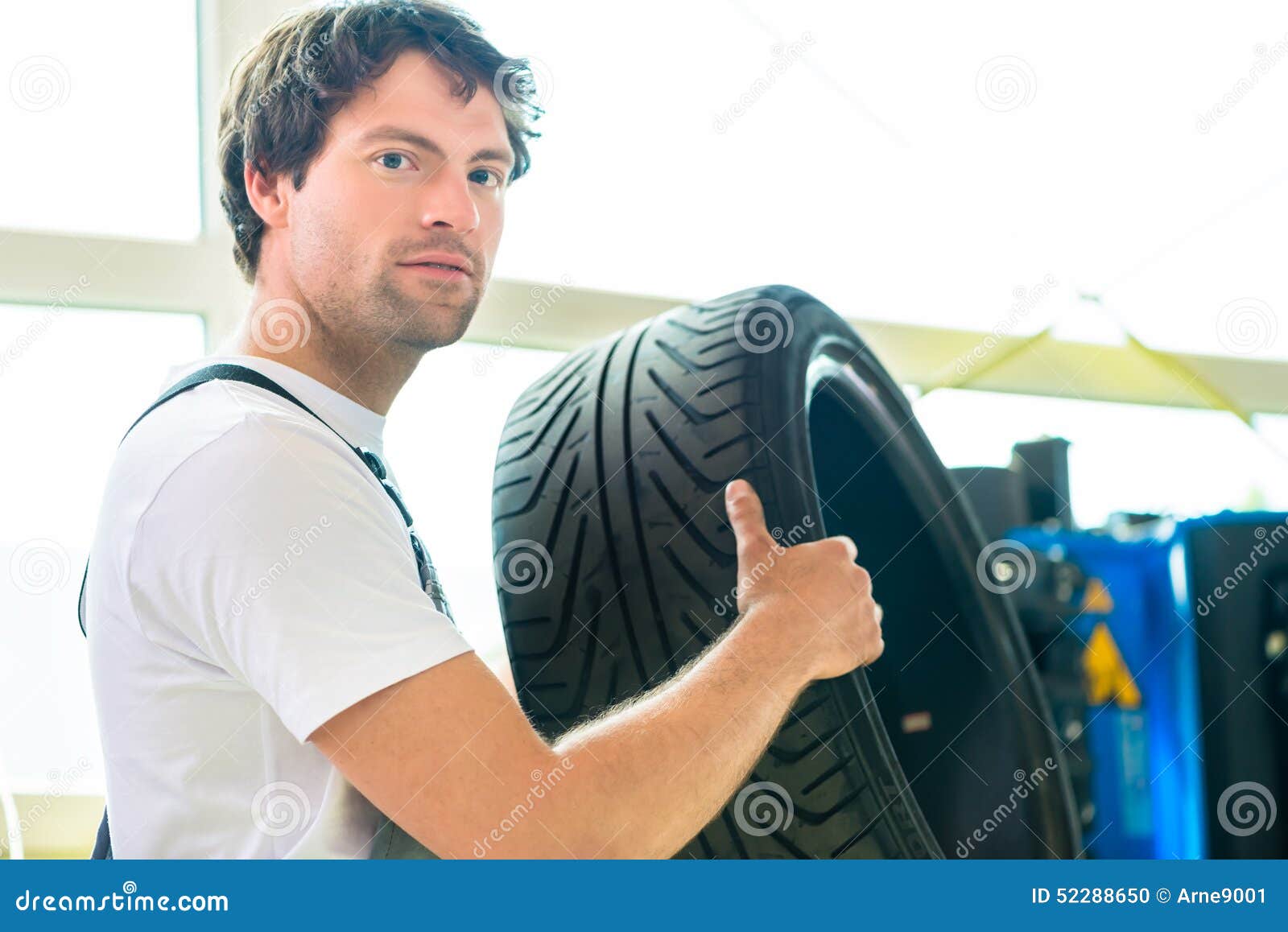 Auto Mechanic Changing Tire in Workshop Stock Photo - Image of normal ...