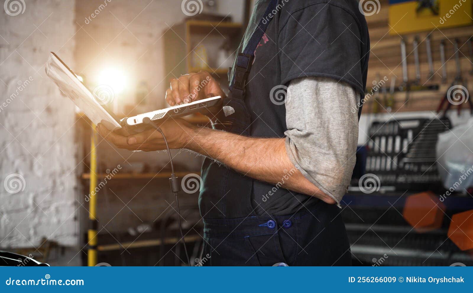 Auto Mechanic Diagnoses a Car Using a Computer. Car Workshop. Close-up ...
