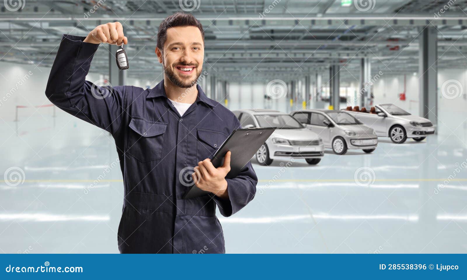 Auto Mechanic Holding Key in a Garage Stock Photo - Image of automotive ...