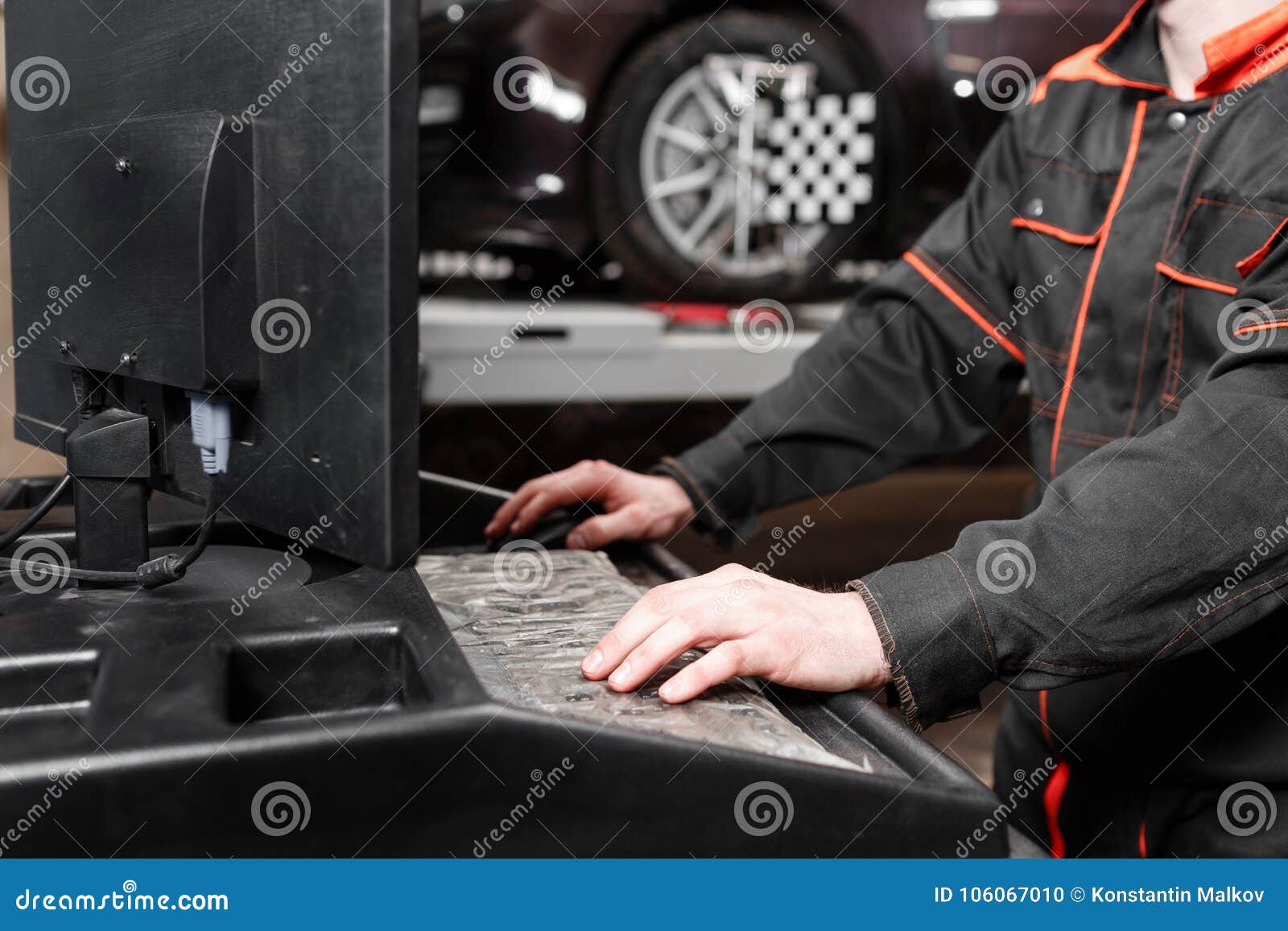 Auto Mechanic Performs Diagnostics and Configuration on the Computer ...