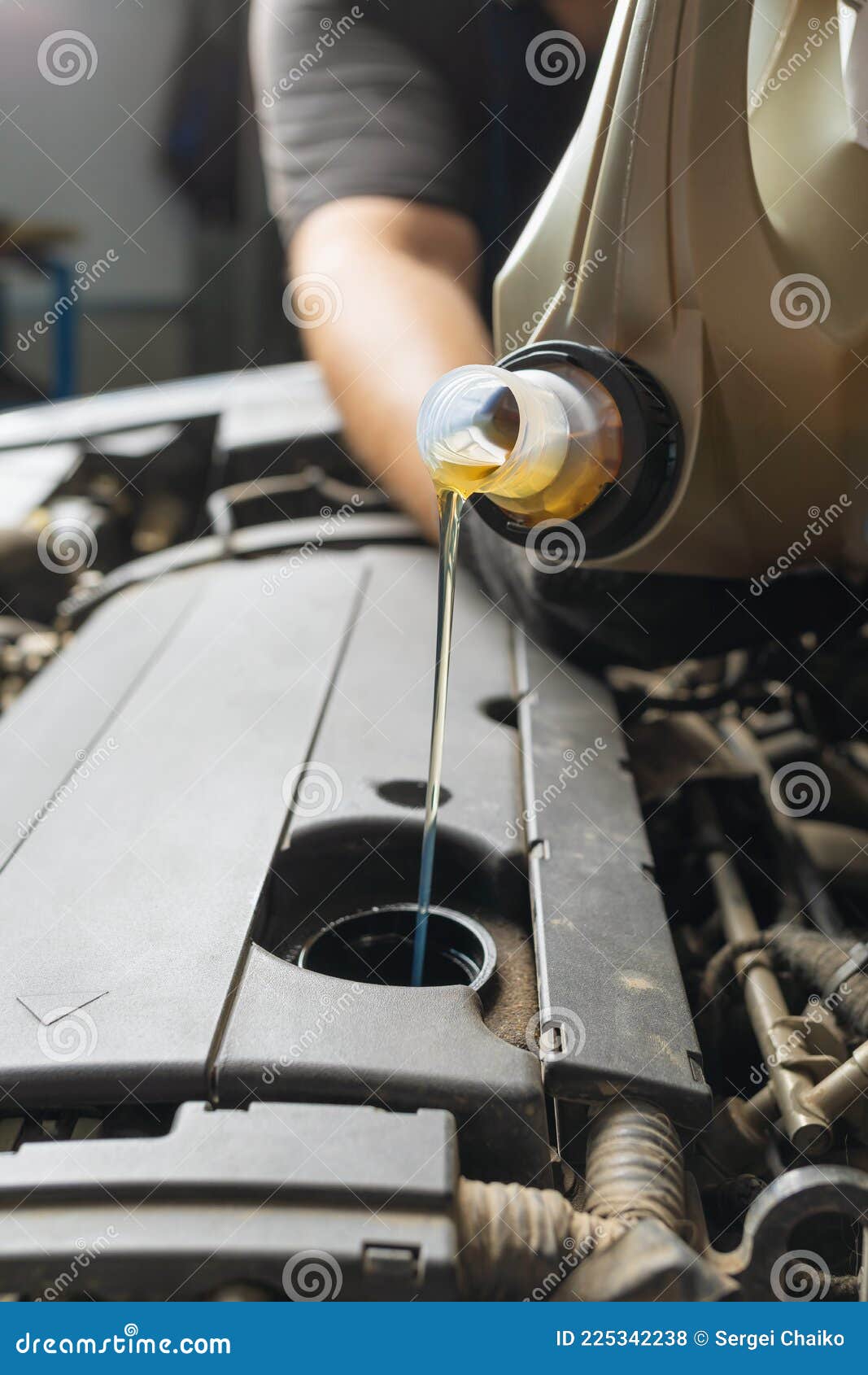 An Auto Mechanic Pours Engine Oil Stock Photo - Image of workshop ...