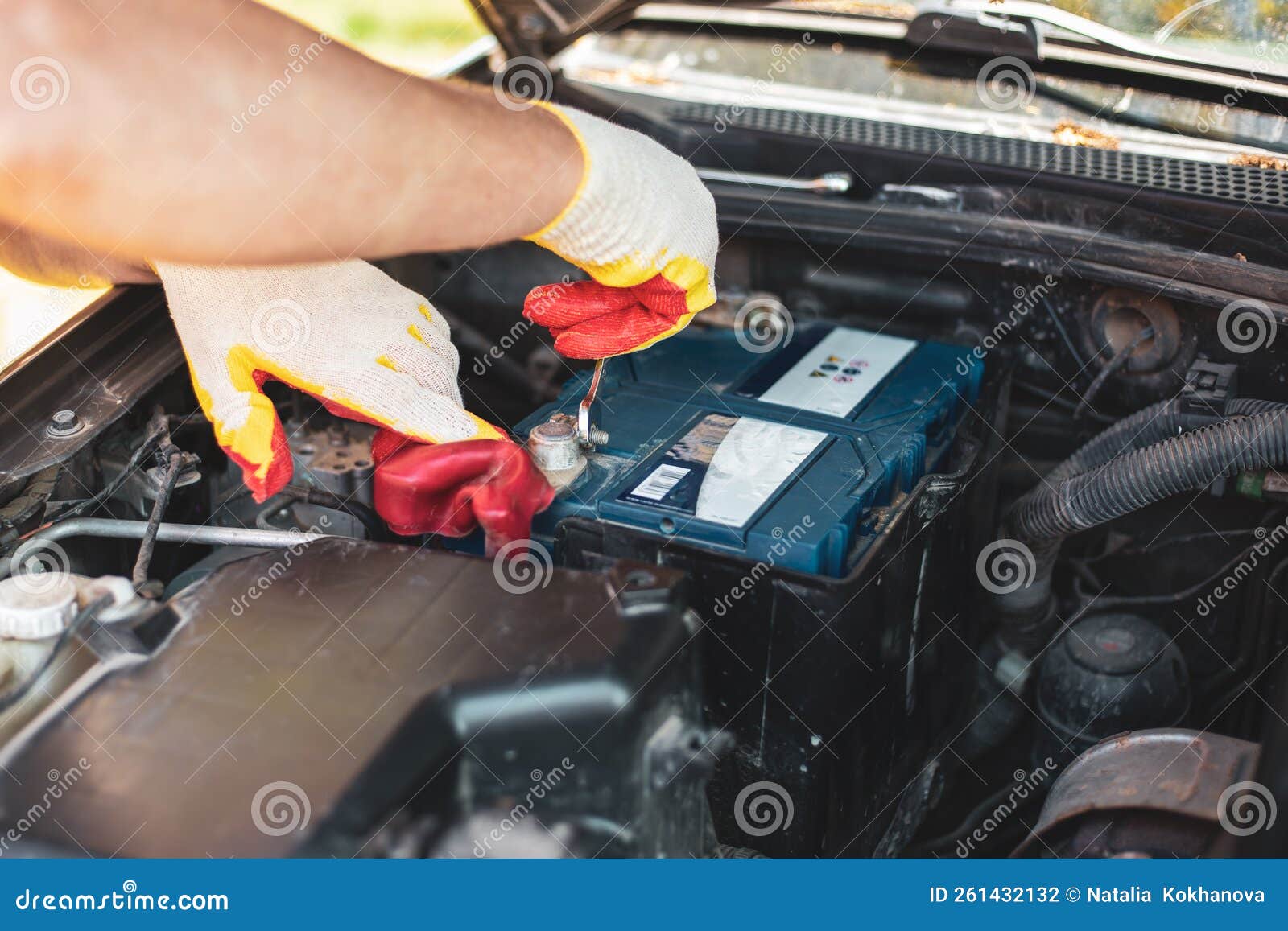 An Auto Mechanic is Repairing a Car. Removing the Battery Stock Photo ...