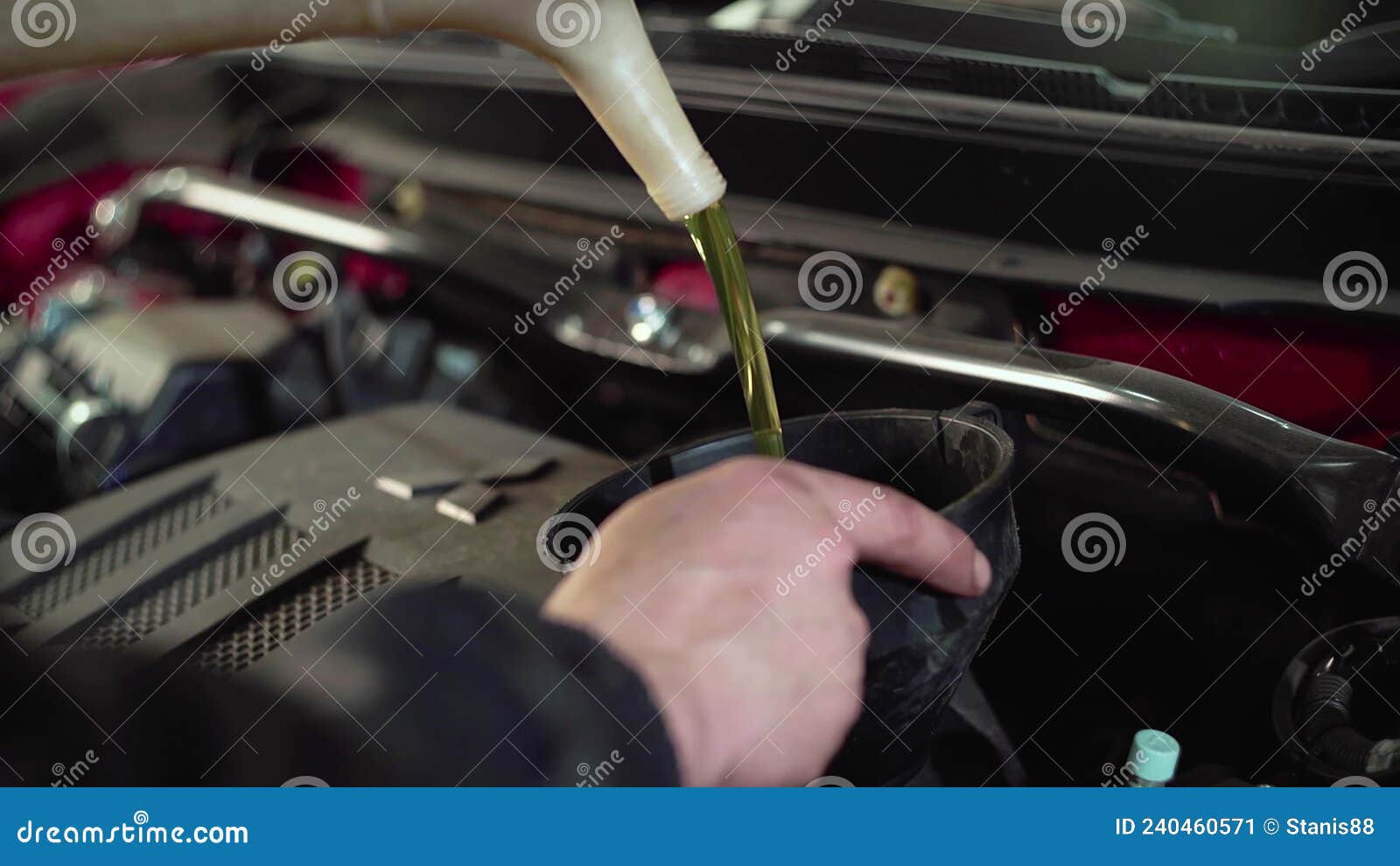 An Auto Mechanic Replaces the Oil in the Car Engine. Stock Video ...