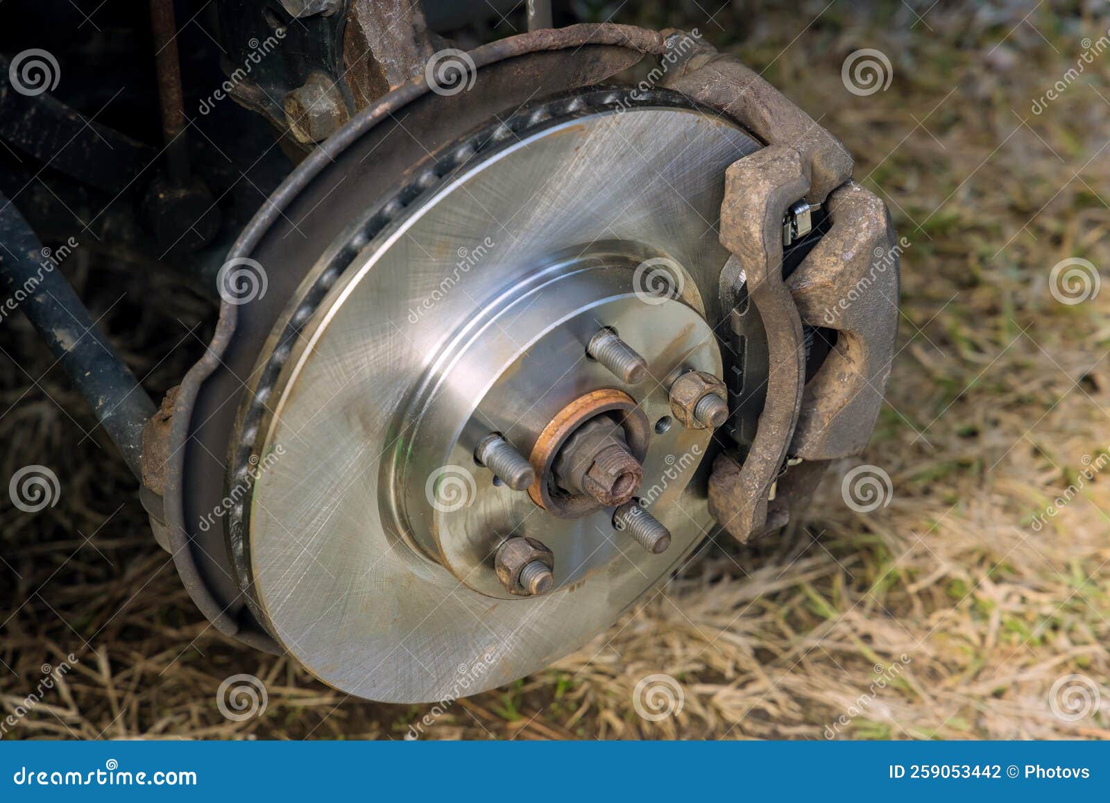 An Auto Mechanic is Replacing the Brake Pads in the System of an ...