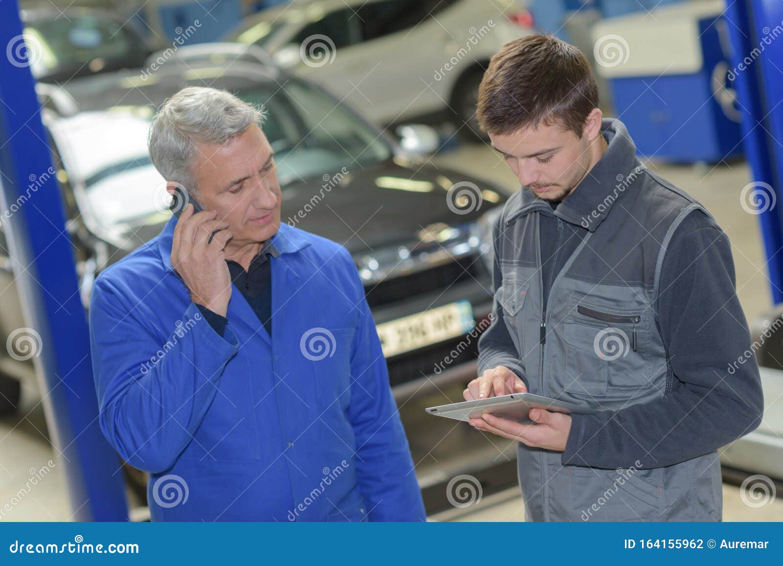 Auto Mechanic Teacher and Trainee Performing Tests at Mechanic School ...