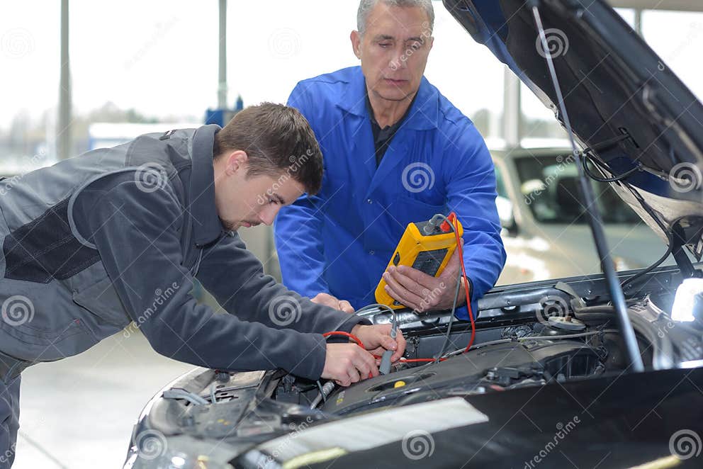 Auto Mechanic Teacher and Trainee Performing Tests at Mechanic School ...