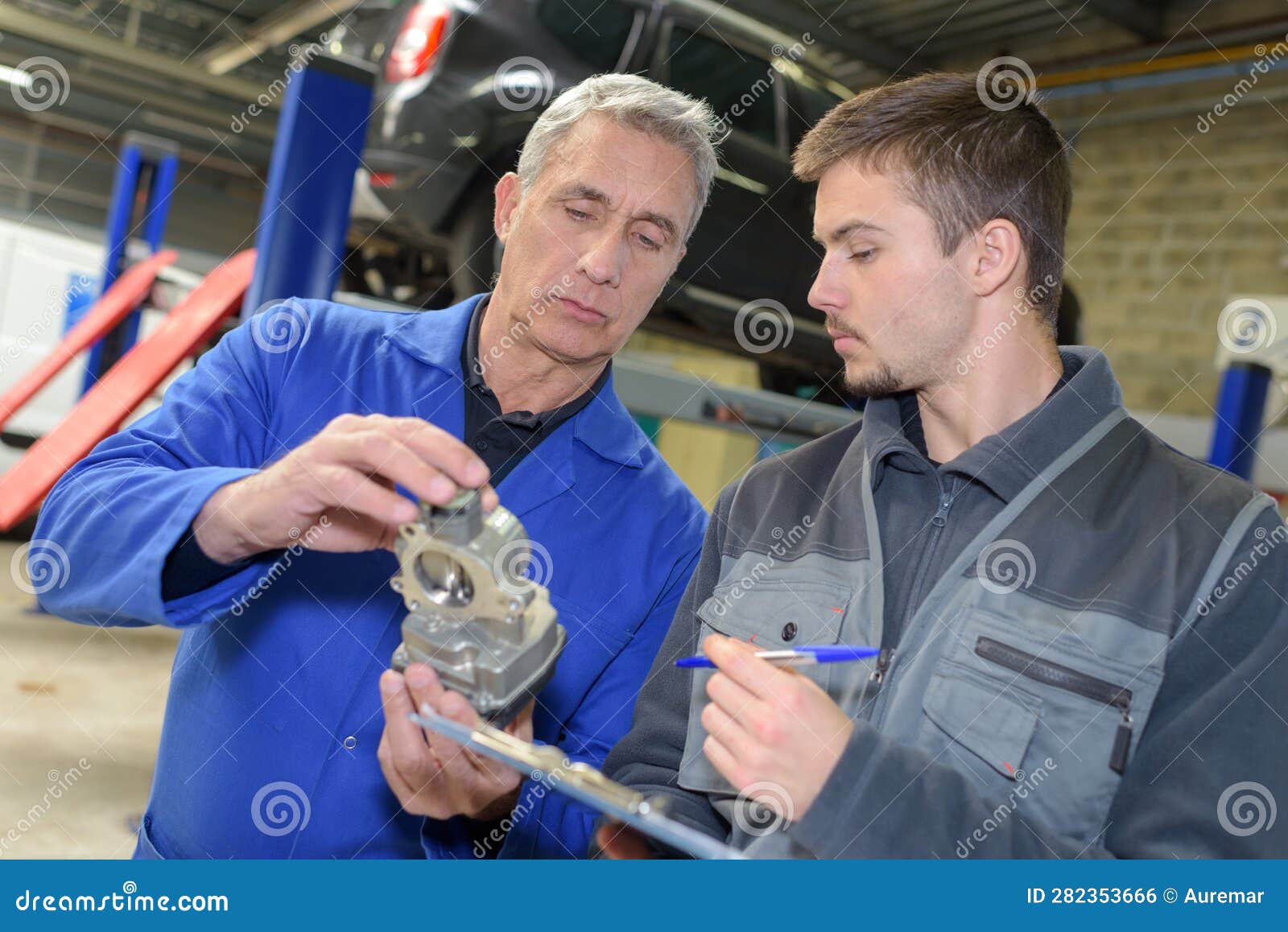 Auto Mechanic Teacher and Trainee Performing Tests at Mechanic School ...
