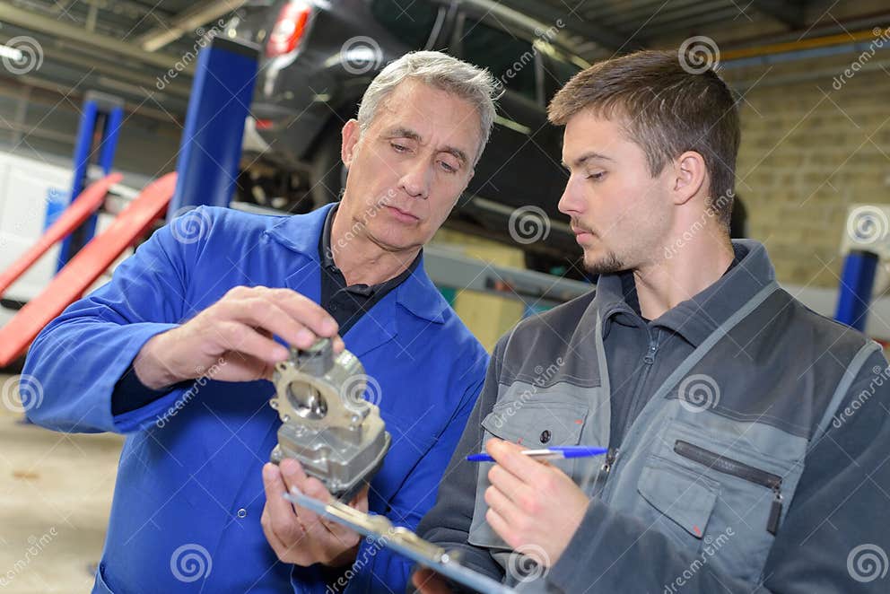 Auto Mechanic Teacher and Trainee Performing Tests at Mechanic School ...