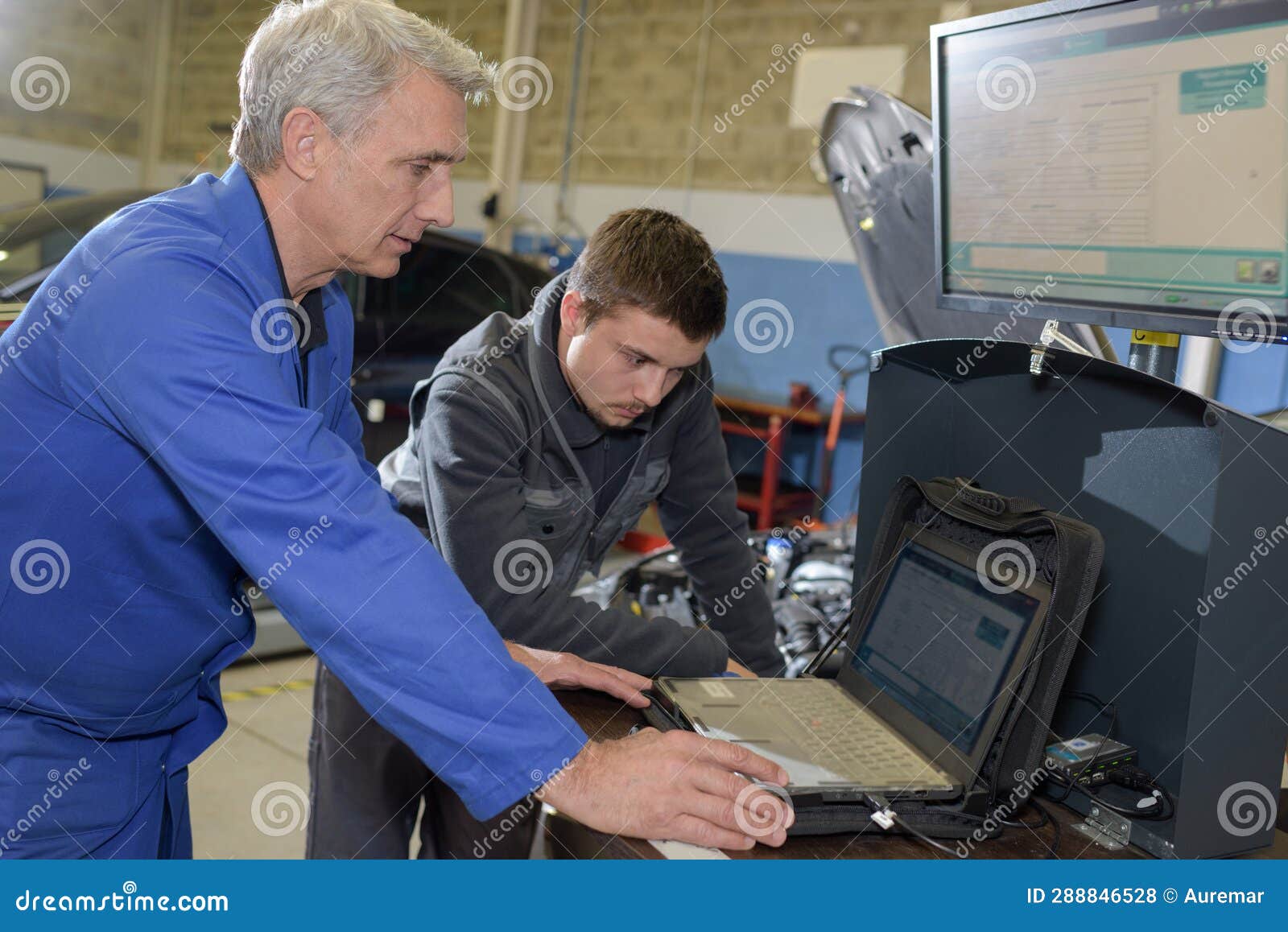 Auto Mechanic Teacher and Trainee Performing Tests at Mechanic School ...