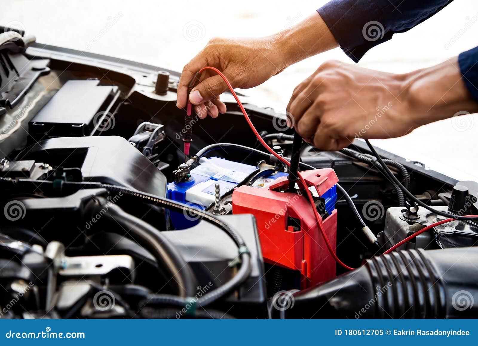 Auto Mechanic Using Measuring Equipment for Checking Car Battery. Stock ...