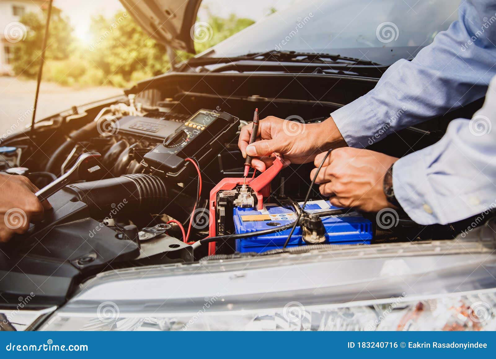 Auto Mechanic Using Measuring Equipment for Checking Car Battery. Stock ...