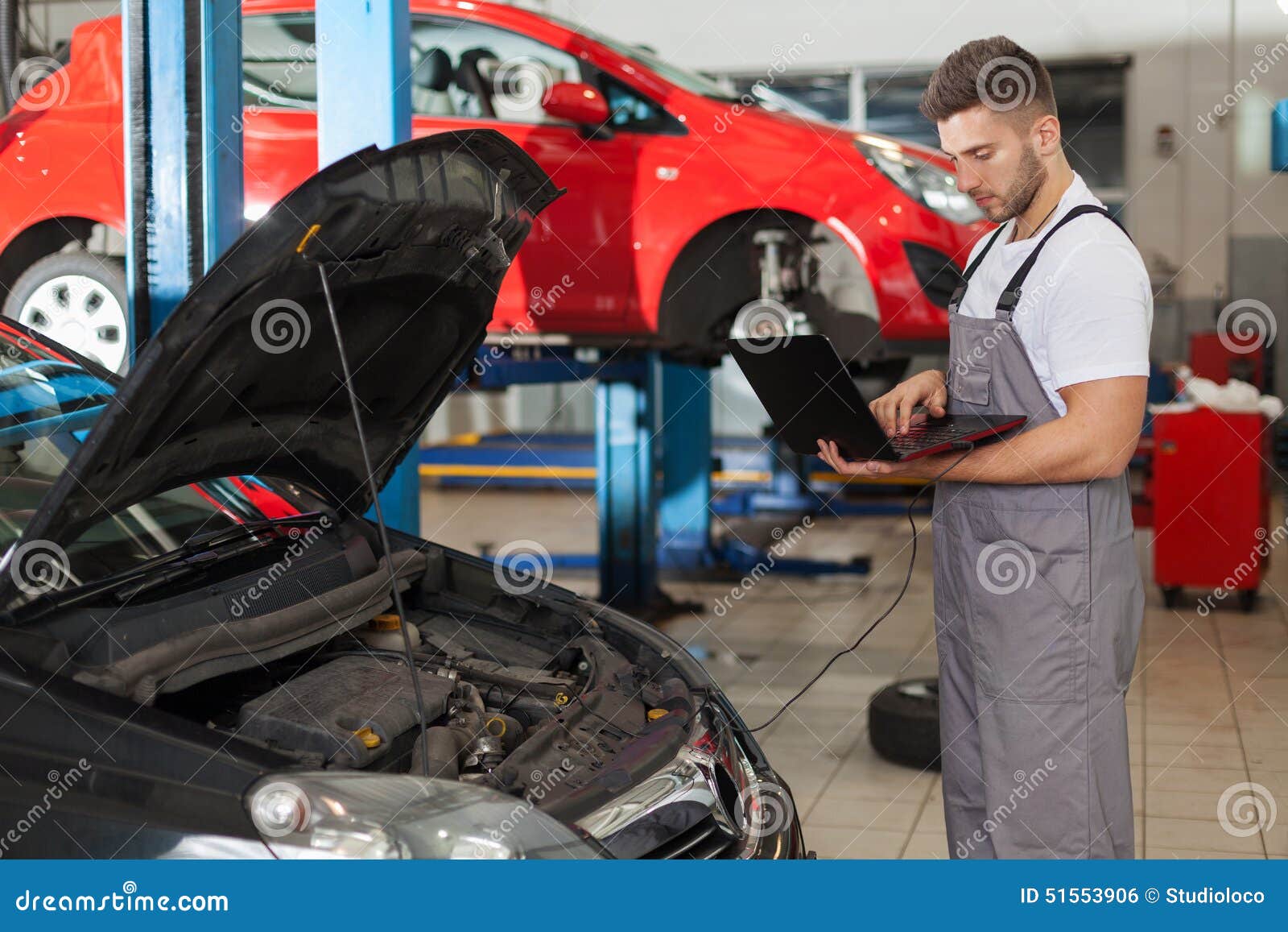 Auto Mechanic Working on a Computer Stock Photo - Image of looking ...