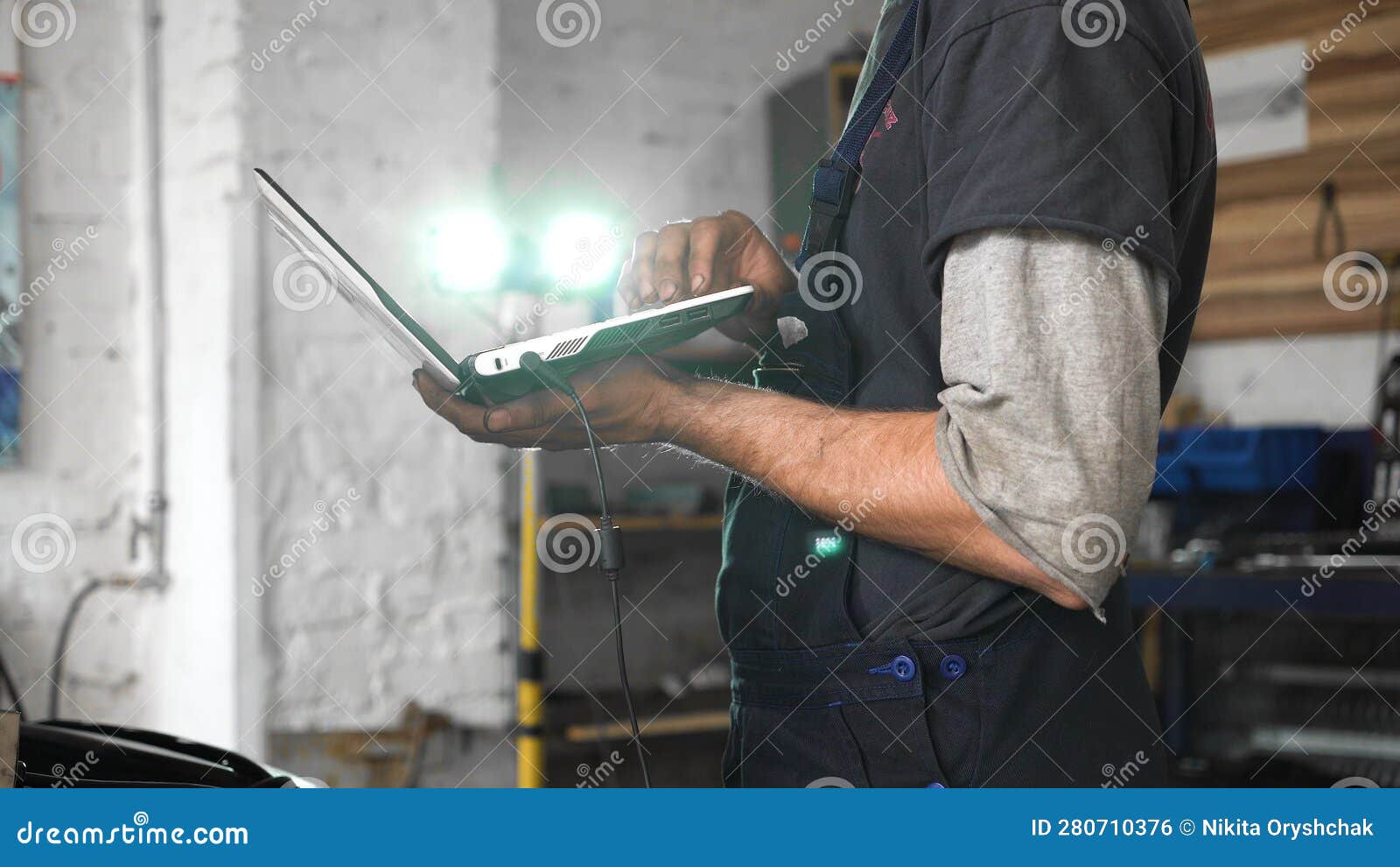Auto Repairman Diagnoses a Car Using a Computer. Car Workshop. Close-up ...
