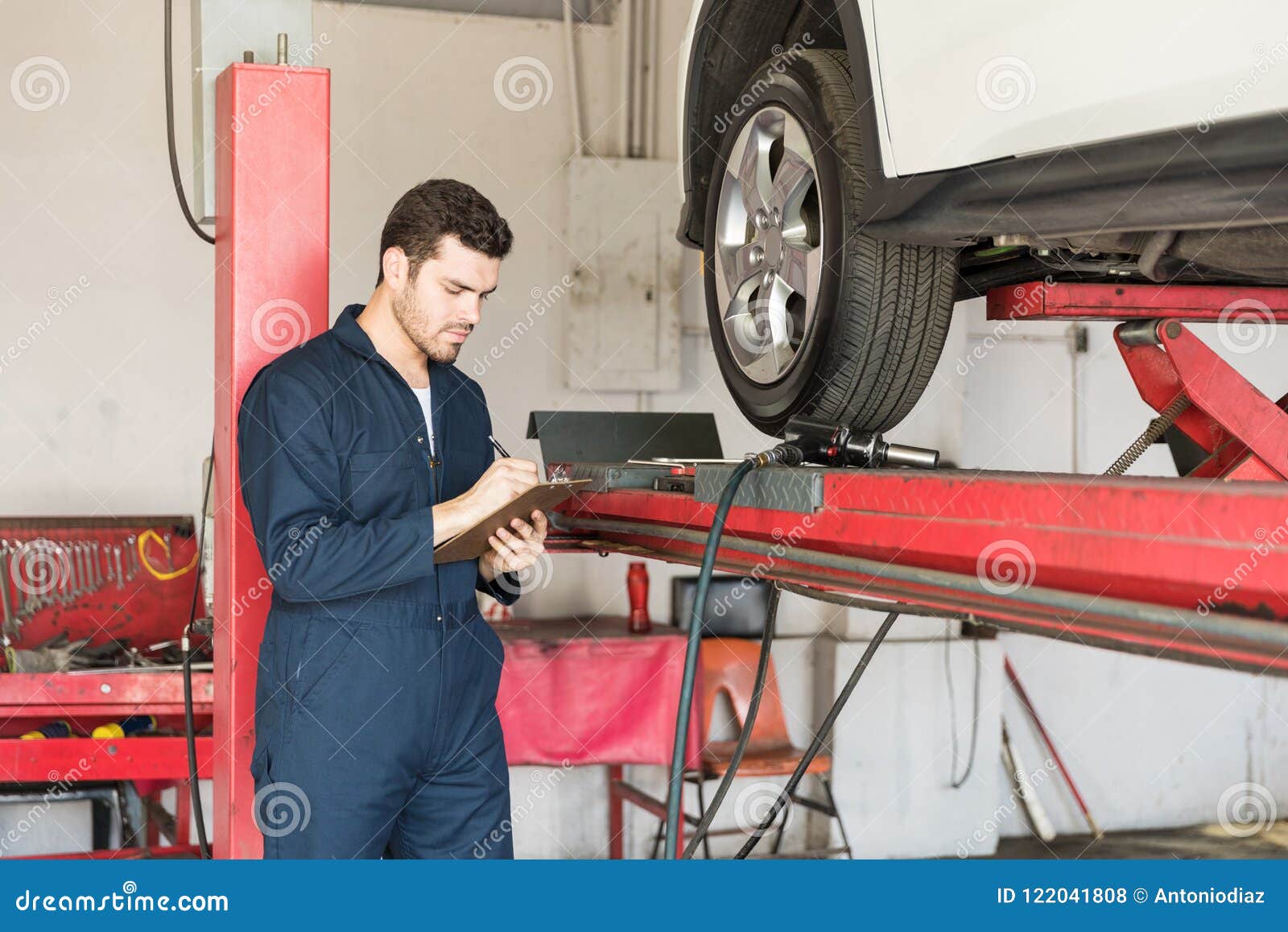 Auto Technician Making Checklist in Garage Stock Photo - Image of ...