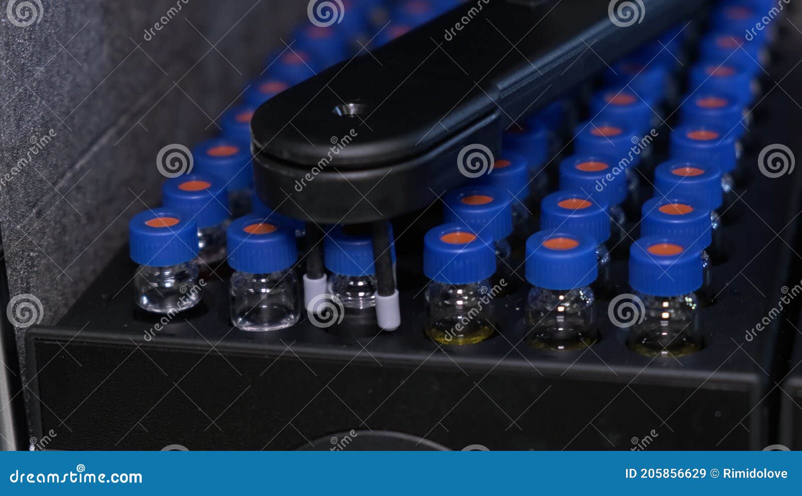 Automated Conveyor Line of Auto Sampler in HPLC System. Vials with Blue ...