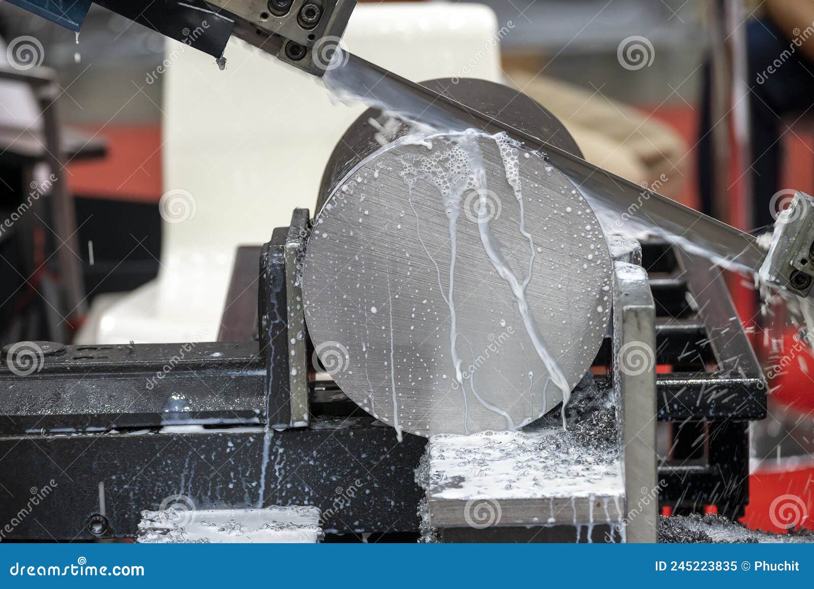 The Automatic Band Saw Machine Cutting the Metal Rod with Water Base ...
