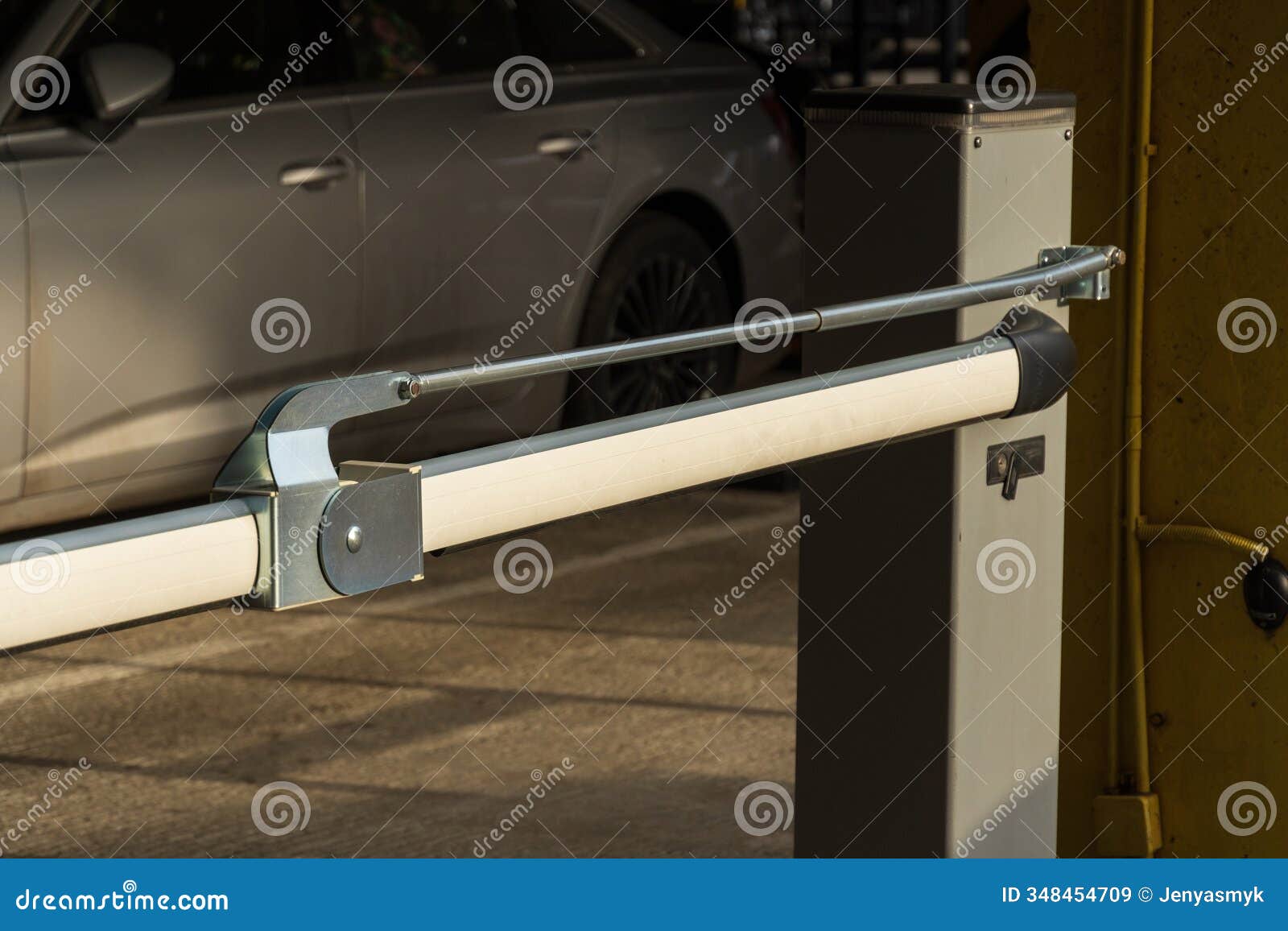 An Automatic Barrier Stands Closed at the Entrance of the Parking Lot ...