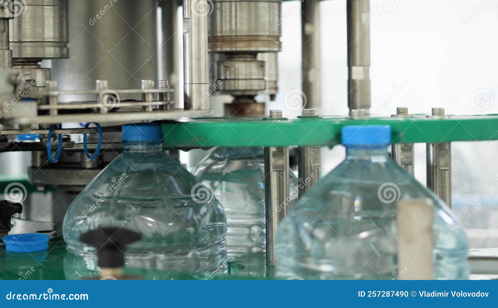 Automatic Capping of Plastic Bottles. Drinking Water Production Line at ...