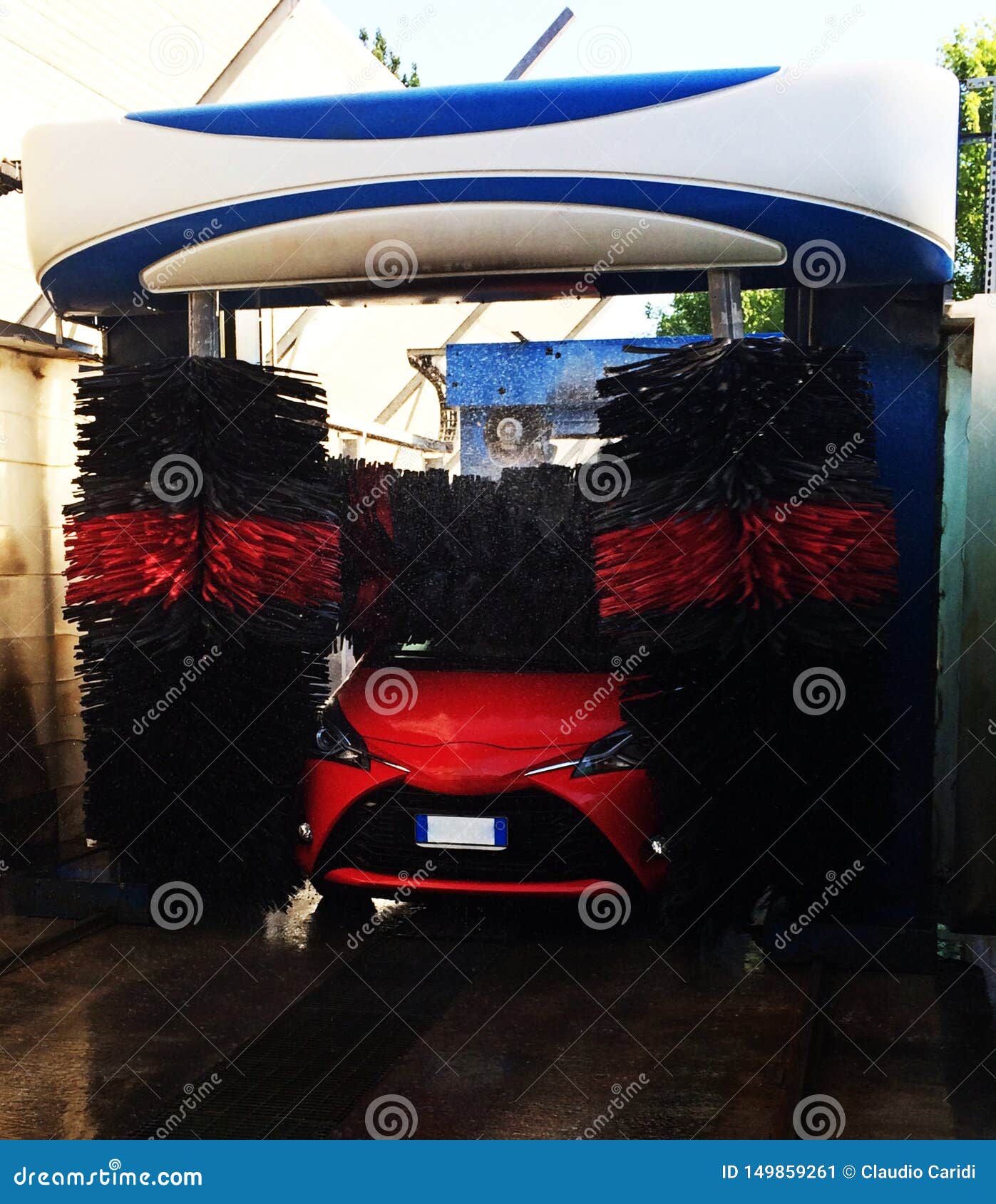Automatic Car Wash in Action, Washing Process on a Red Car Stock Image ...