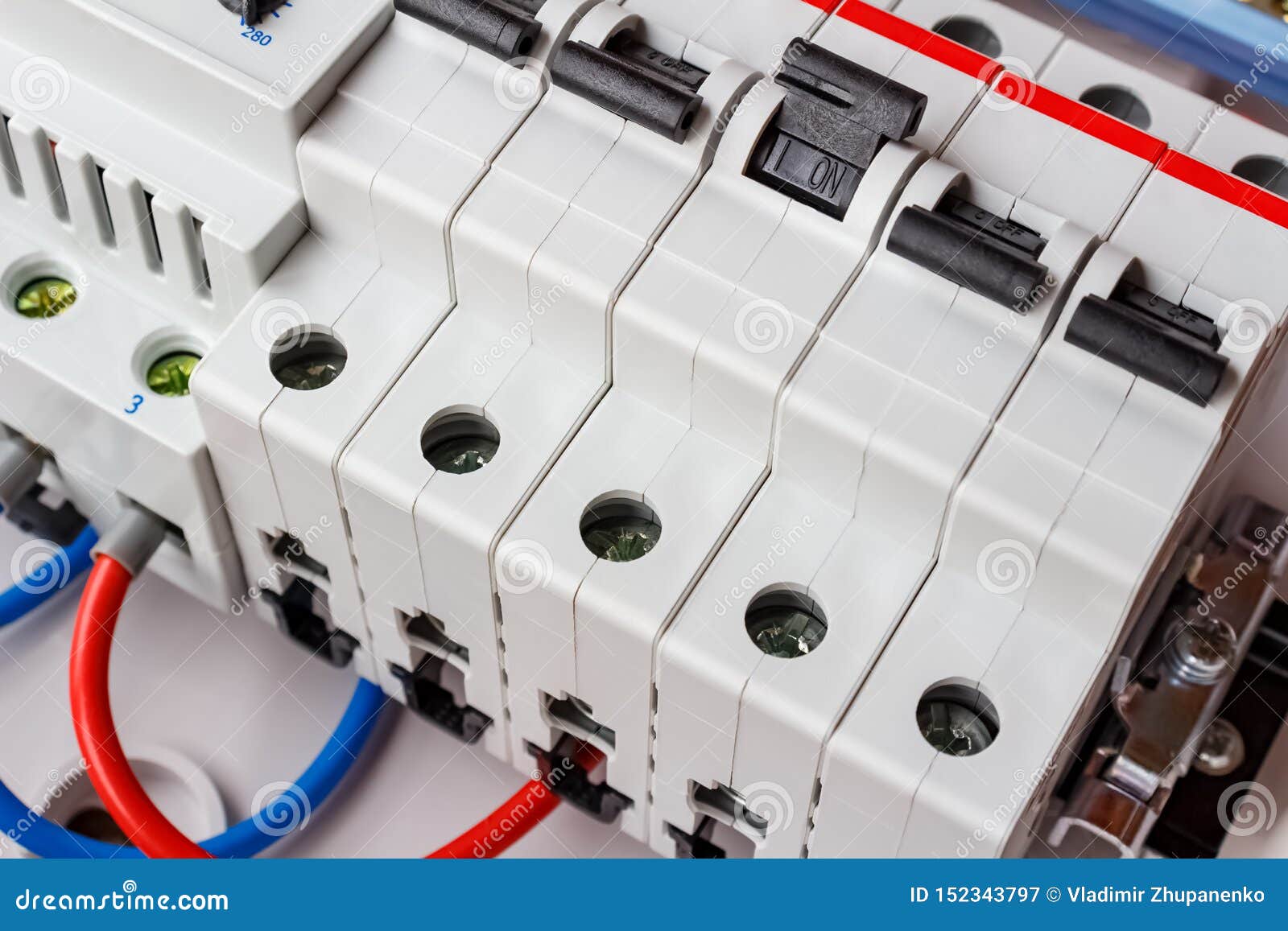 Automatic Circuit Breakers on DIN Rail Closeup in the White Plastic ...