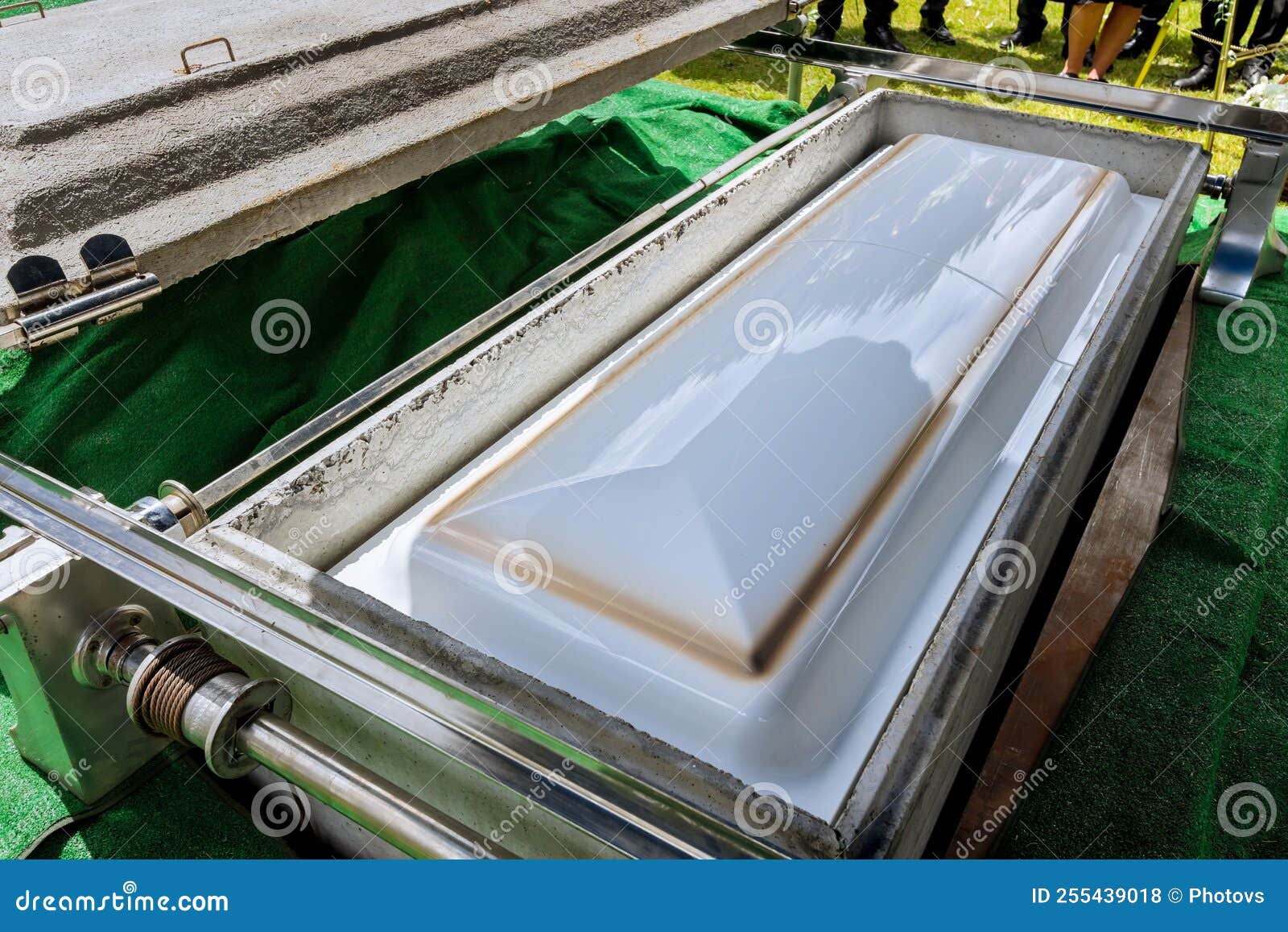 An Automatic Elevator is Used To Lower the Coffin into a Grave by Means ...
