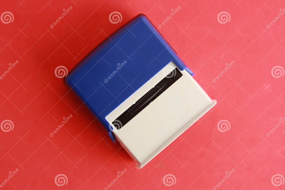 Automatic Ink Stamp on a Red Surface Stock Image - Image of text ...