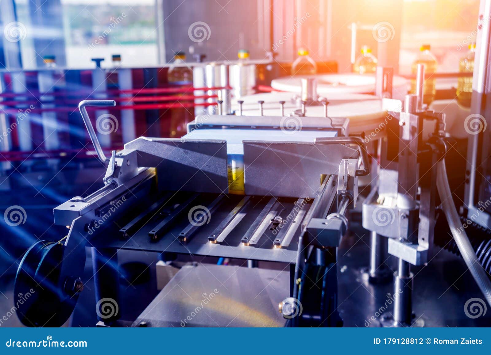 Automatic Labeling Machine during Operation. Factory for the Production ...