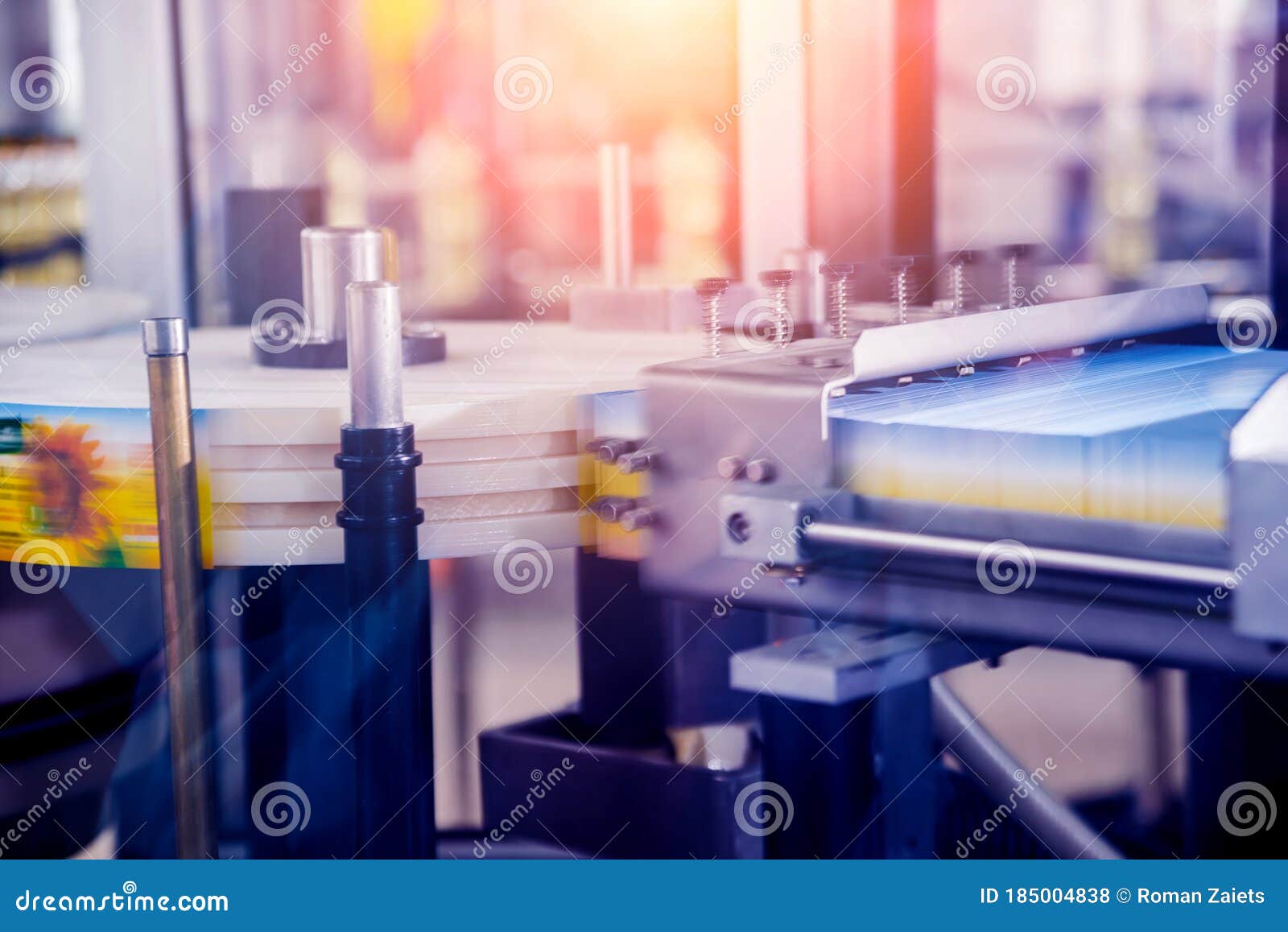 Automatic Labeling Machine during Operation. Factory for the Oil ...