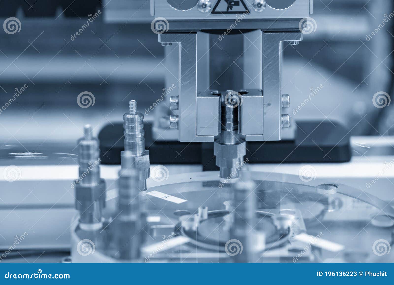 The Automatic Robotic Arm Gripping the Spark Plug Part in Production ...
