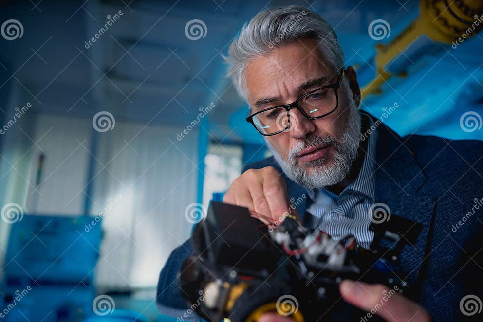 Automation, Robotics Engineer Assembling Robotic Car Prototype for ...